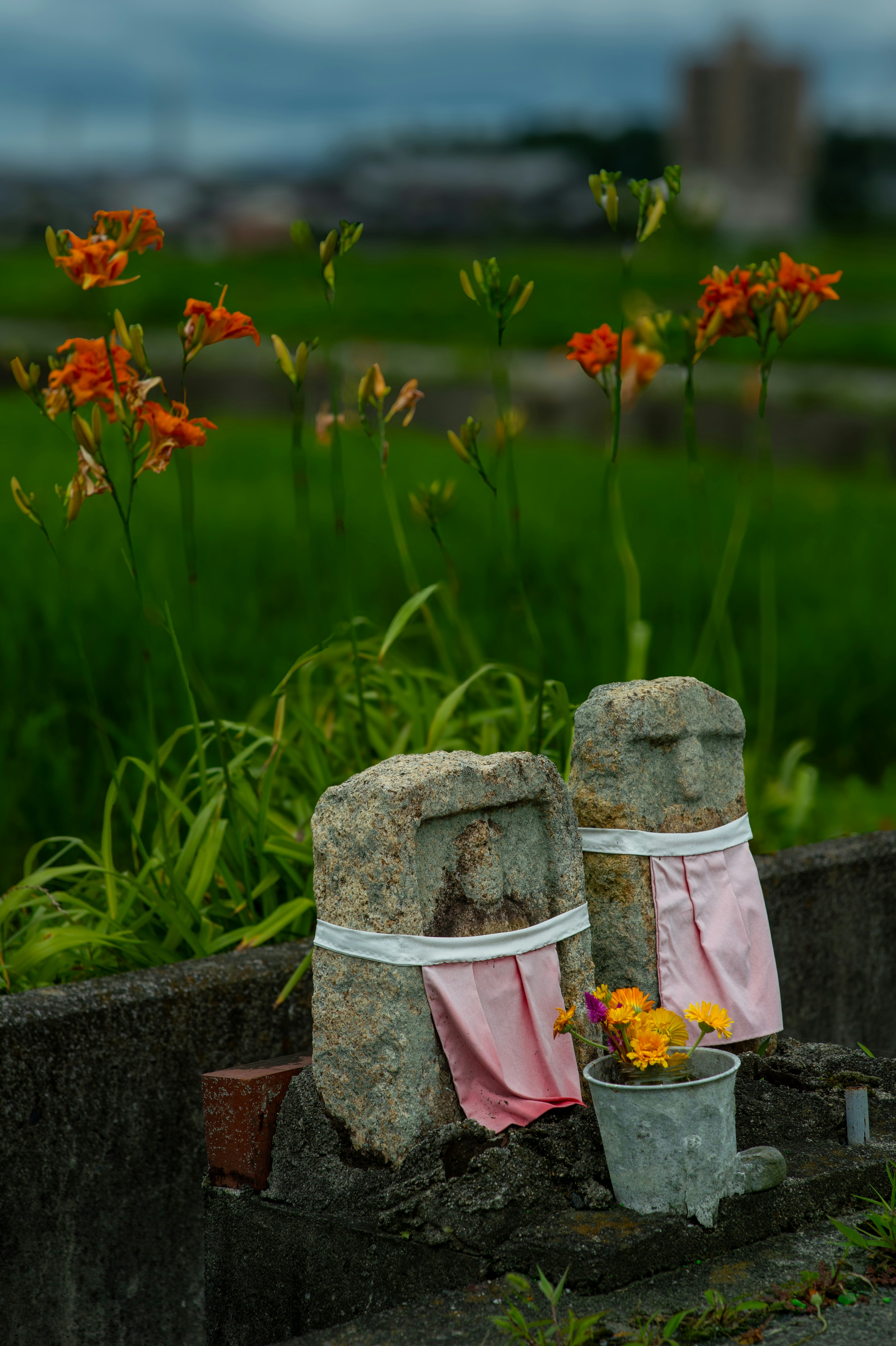Colorful shrine of flowers: weathered posts with pink ribbons