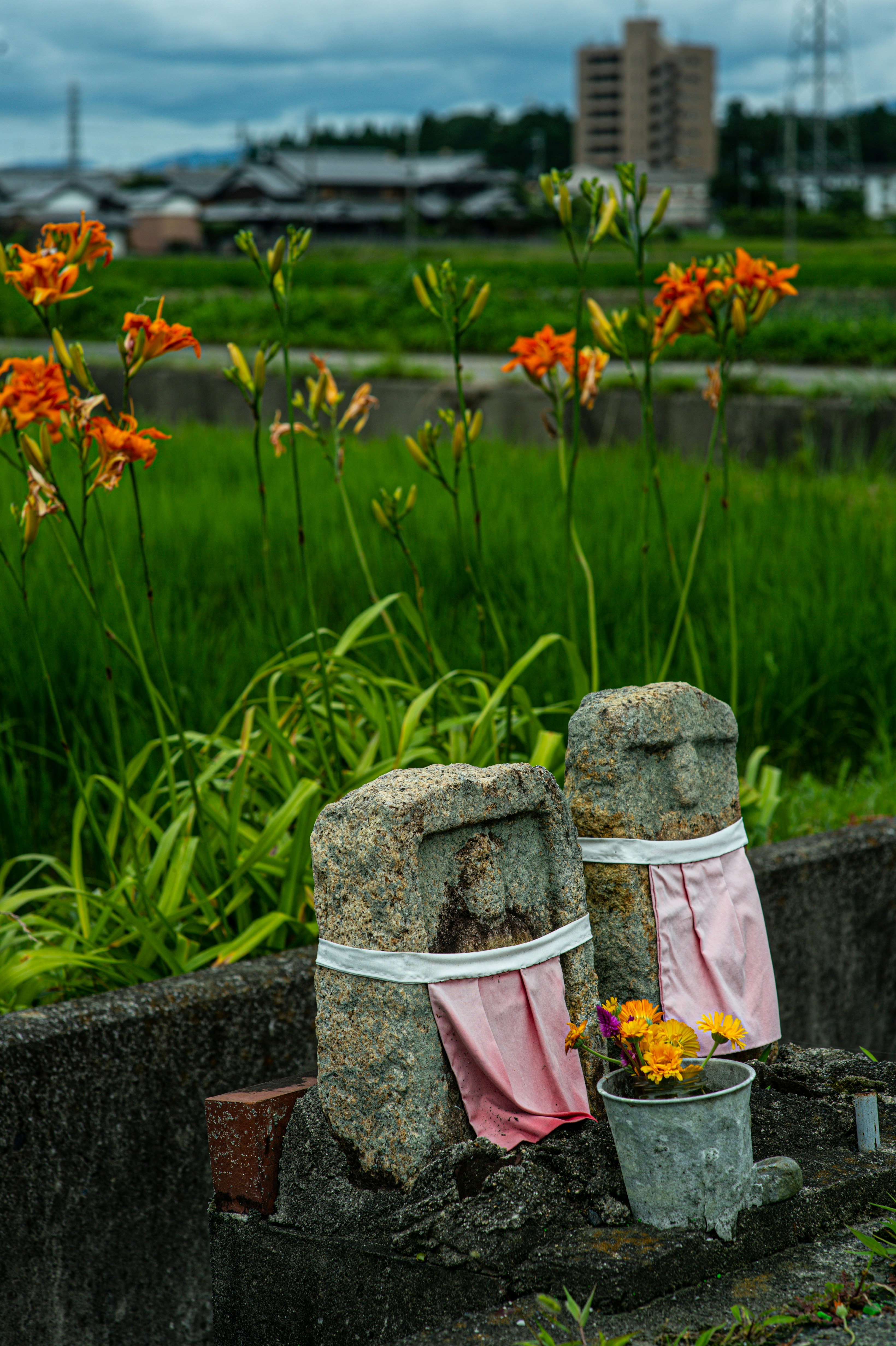 Volunteer Shrine Adorned with Flowers beside Quiet Canal
