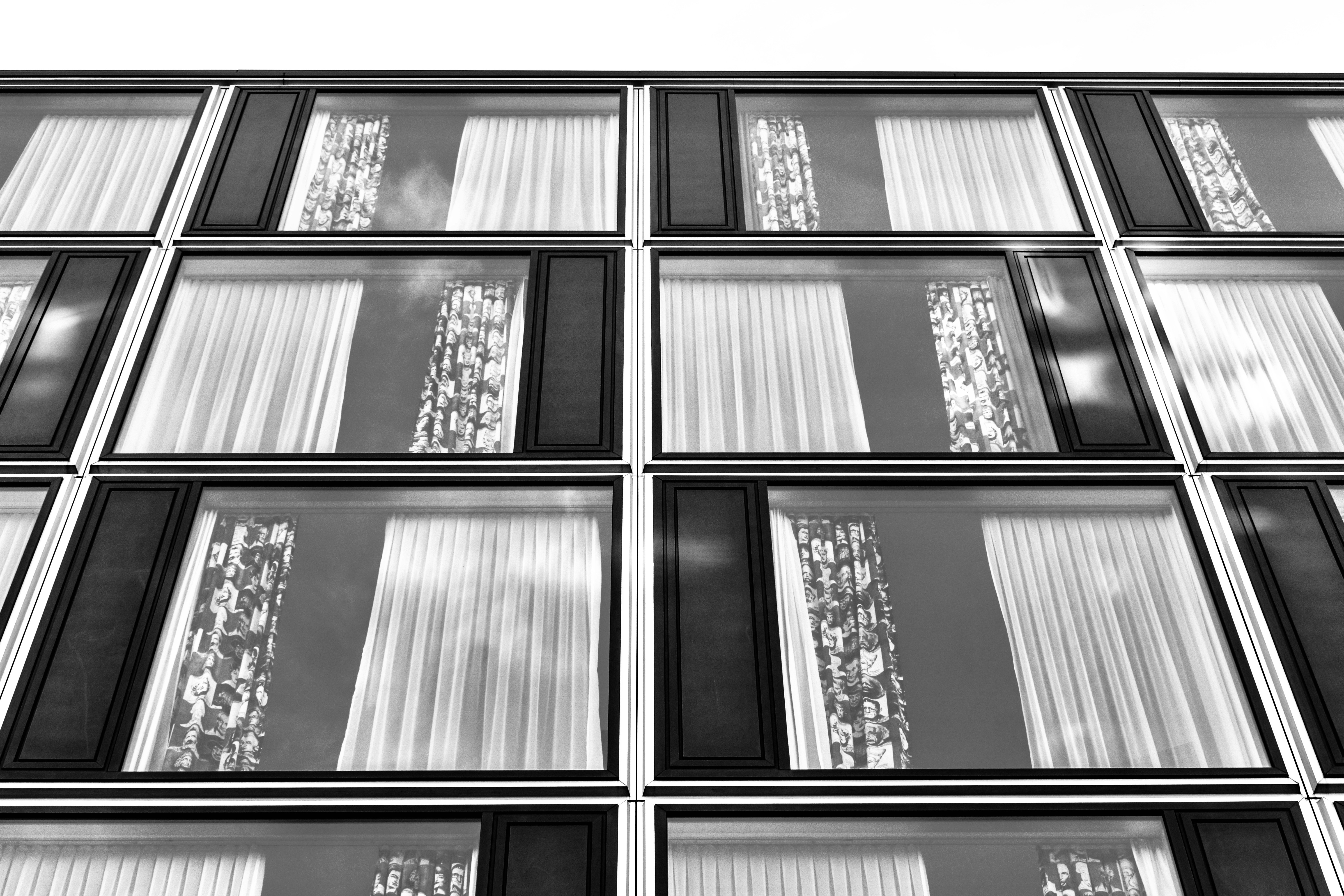 Grid of Silvered Panes: A Monochrome Facade in Repeating Frames