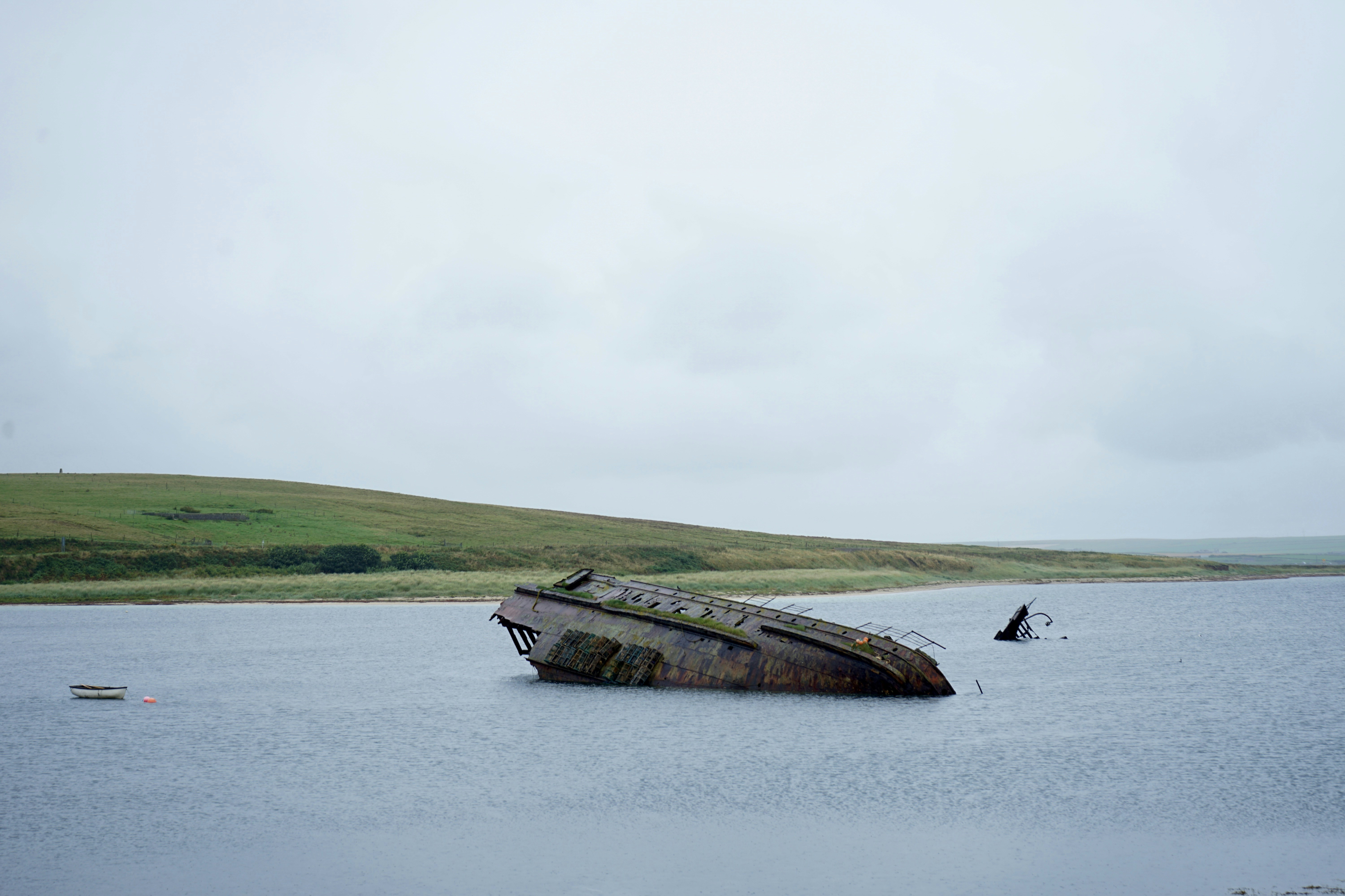 Wrecked hull resting in a tranquil tidal lagoon