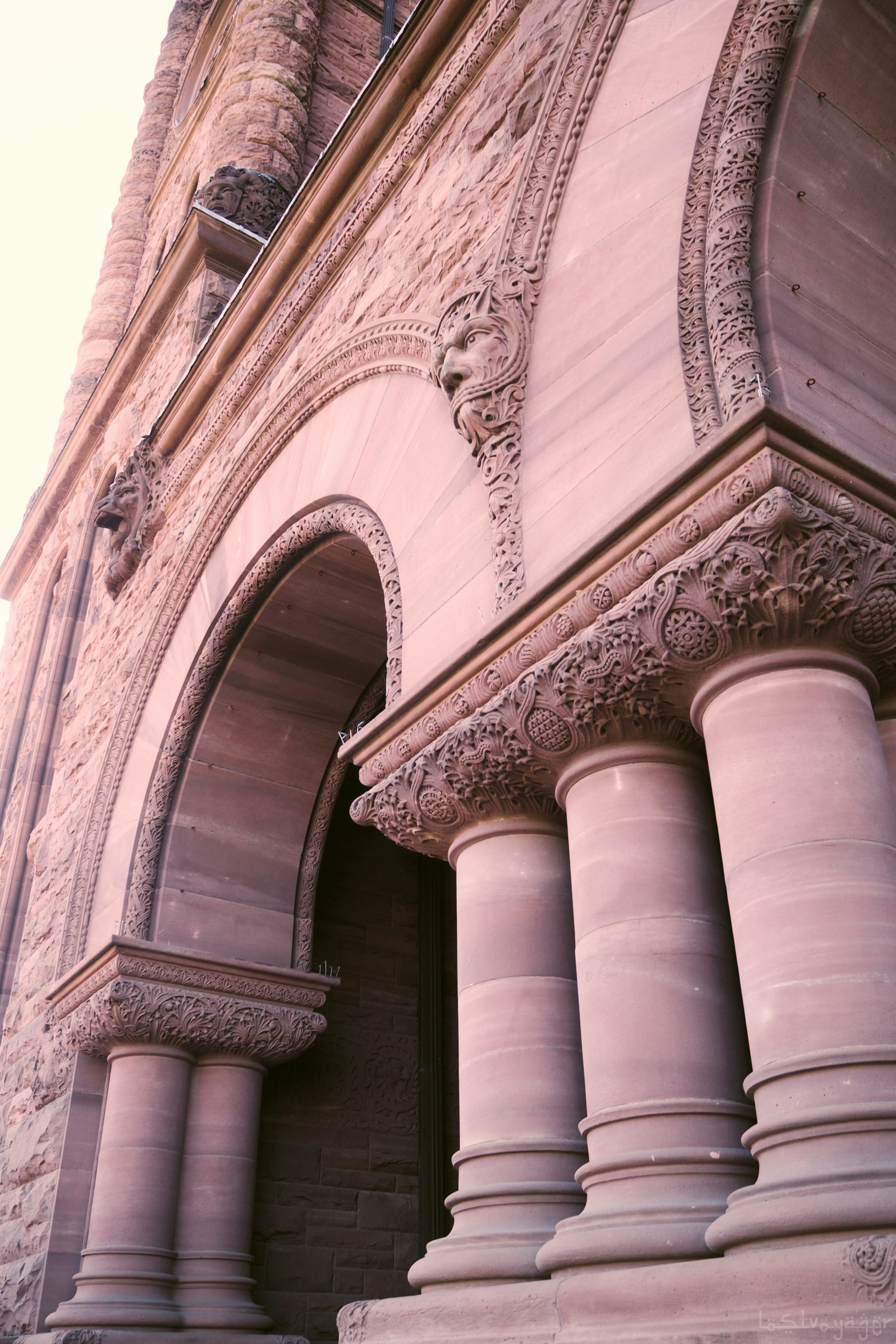 Carved Archway and Pillared Entrance in Pink-Hued Stone