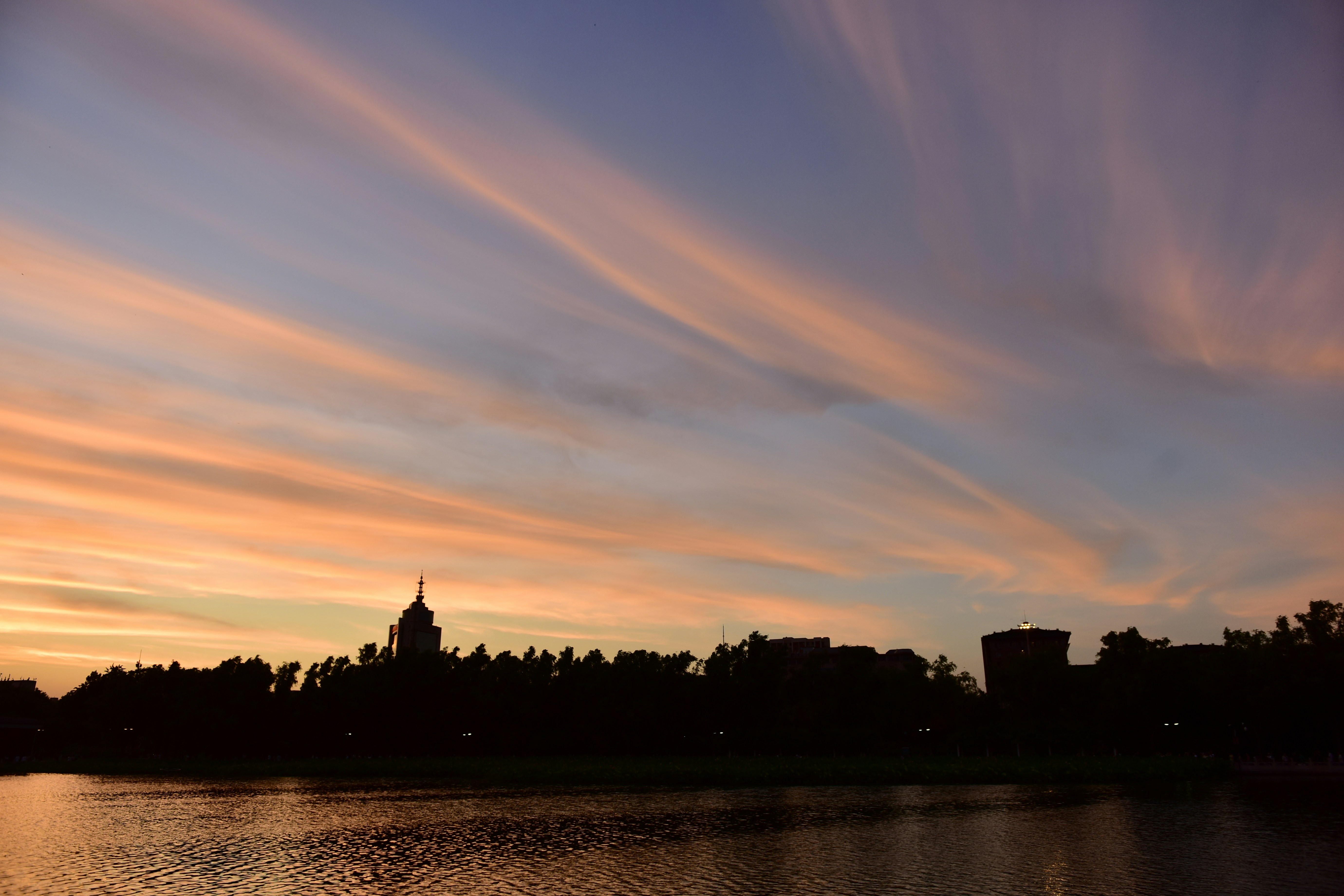 Silhouette Skyline at Dusk over Quiet Waters