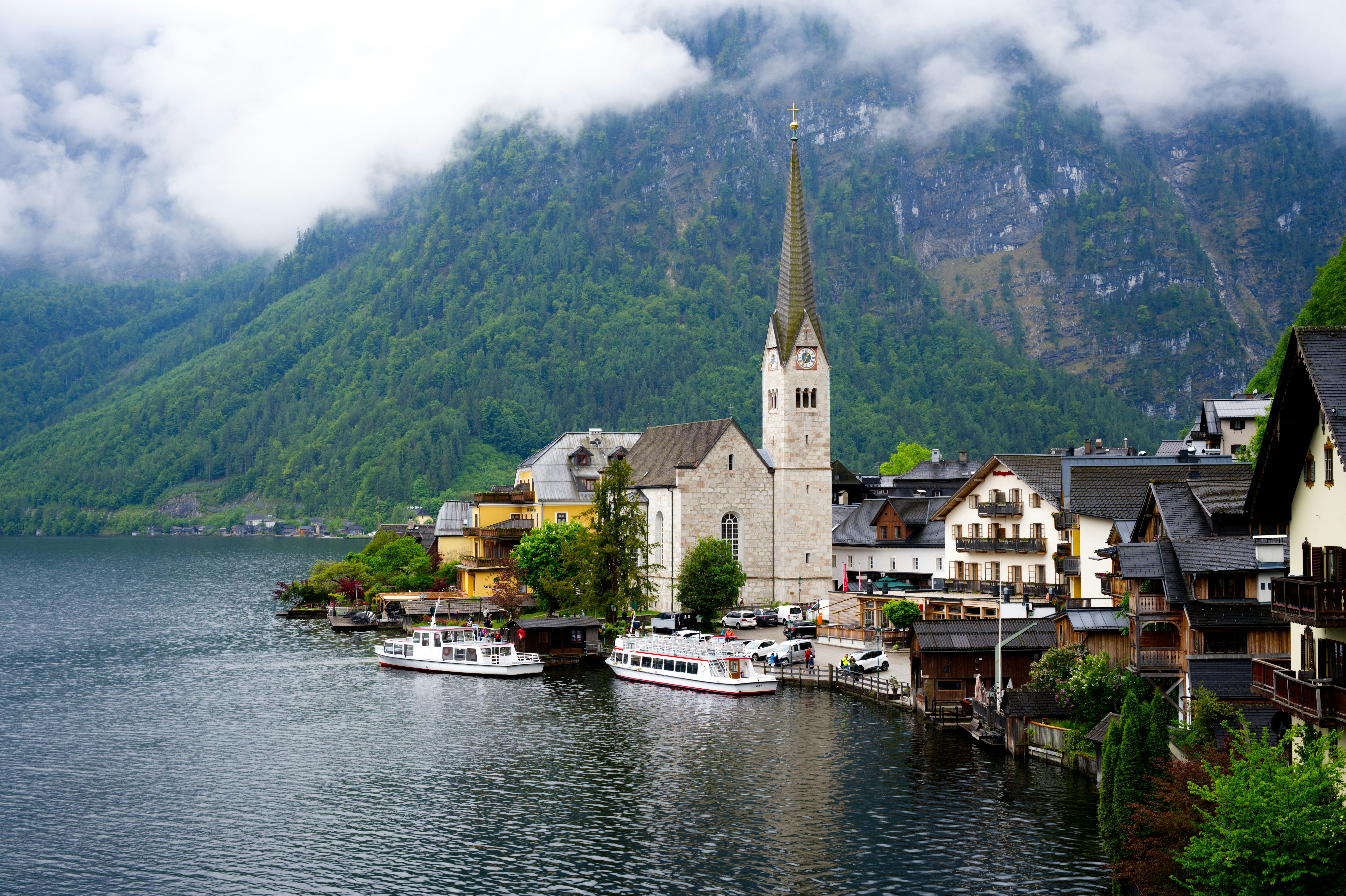 Alpine Lakefront: A church steeple among timbered houses by the water