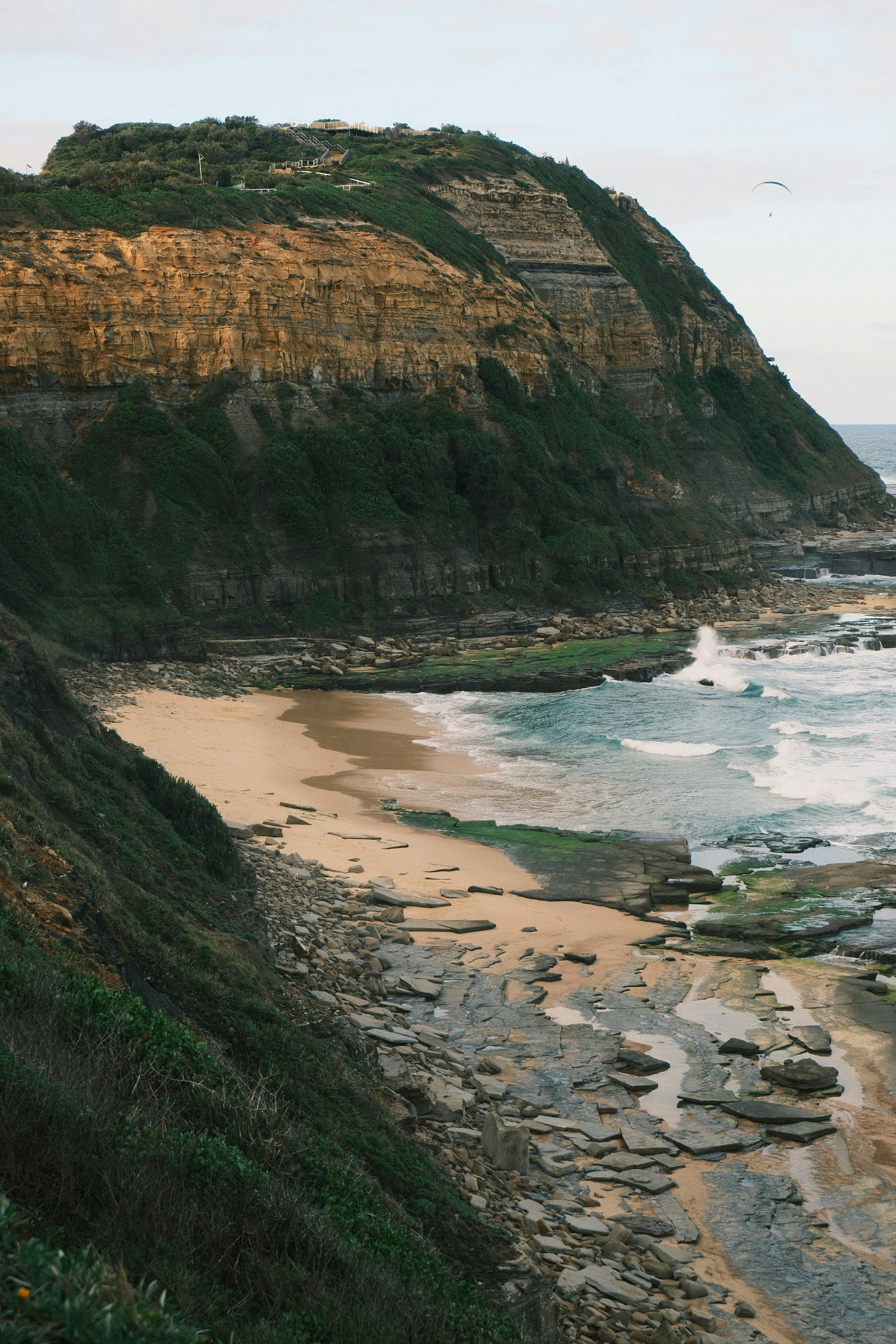Cliffside Shoreline: A Quiet Convergence of Rock, Sand, and Sea