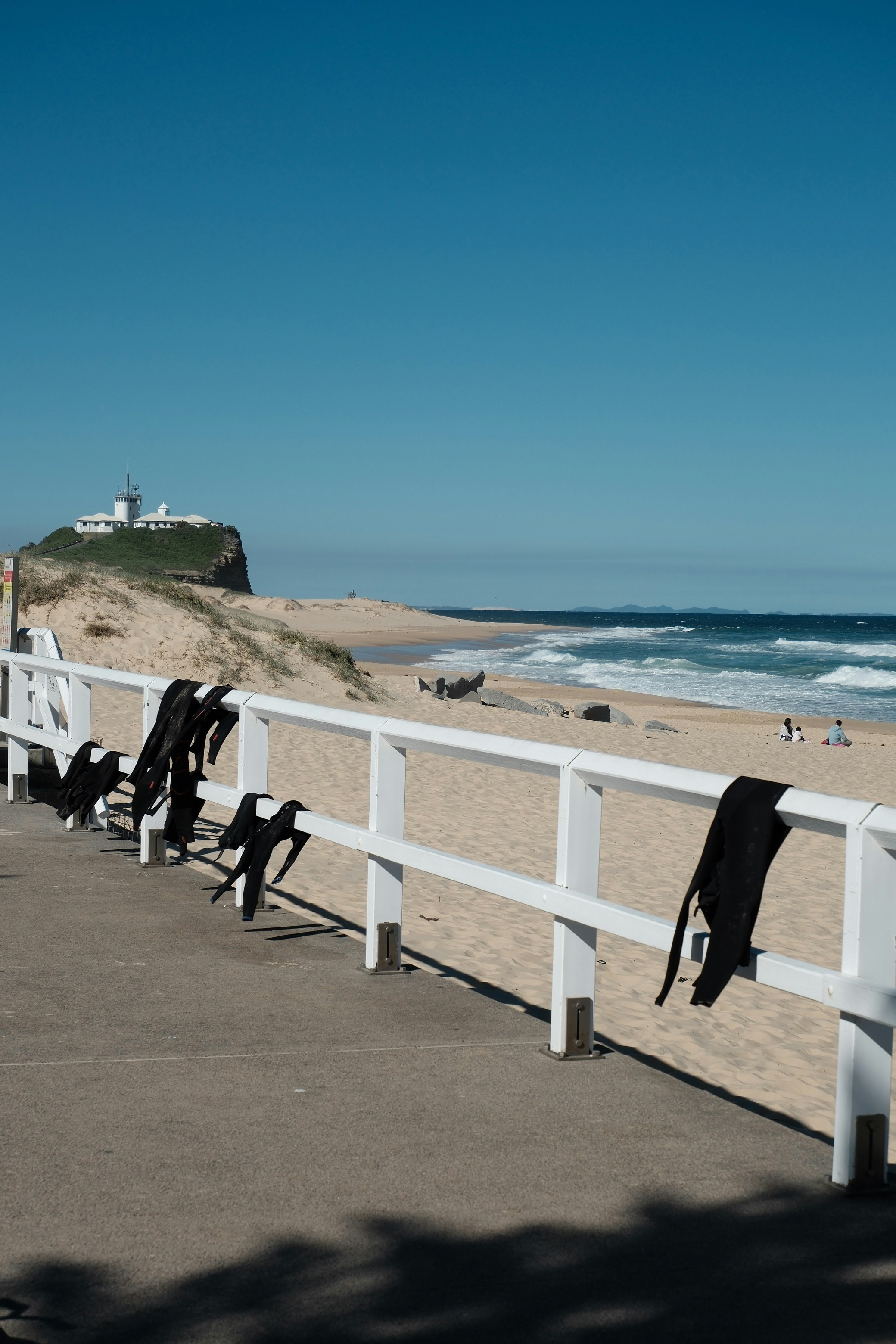 White railing leading to a coastal horizon