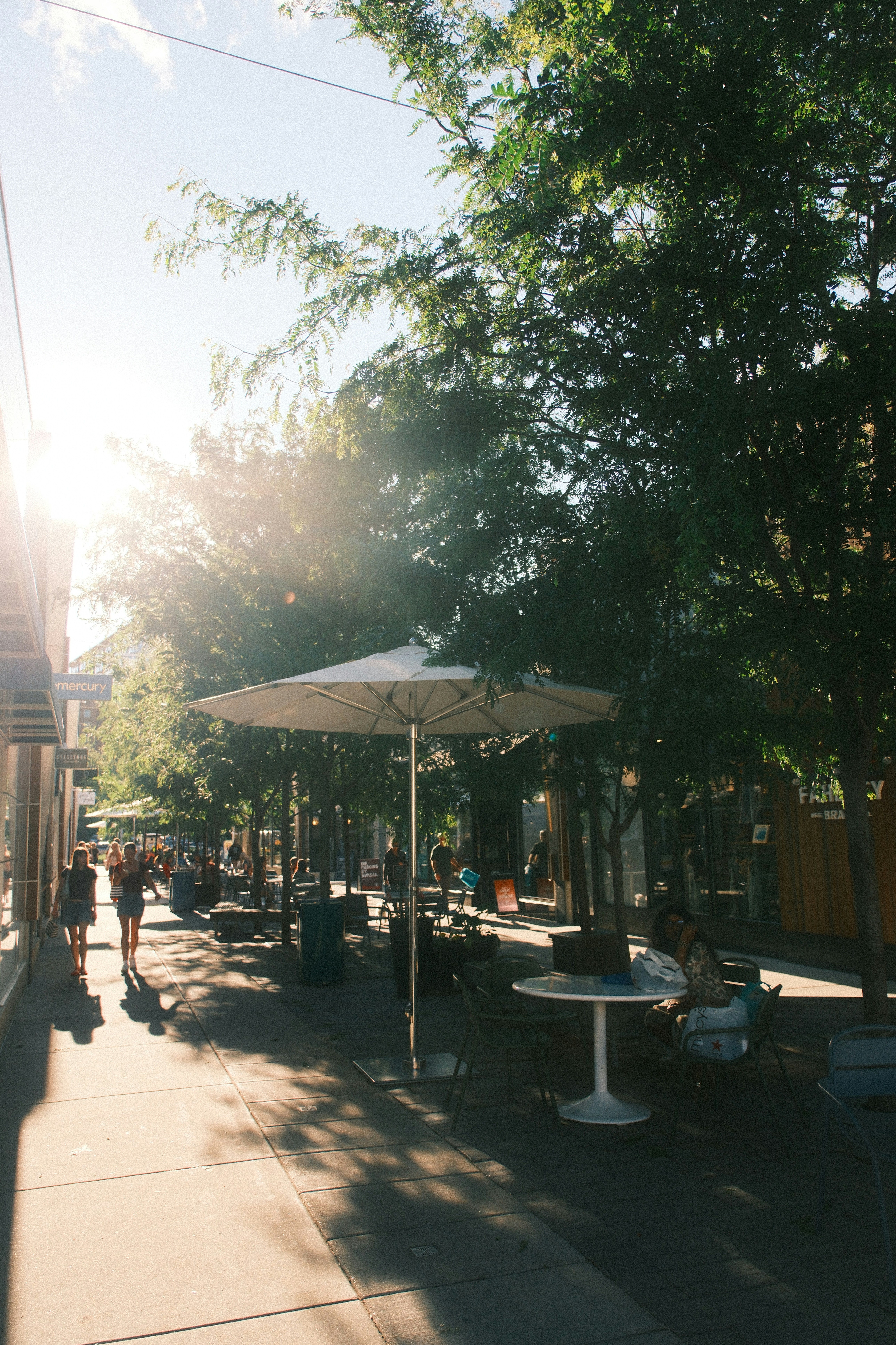 Sunlit Street Café: Shadows, Pillars and a Quiet Afternoon