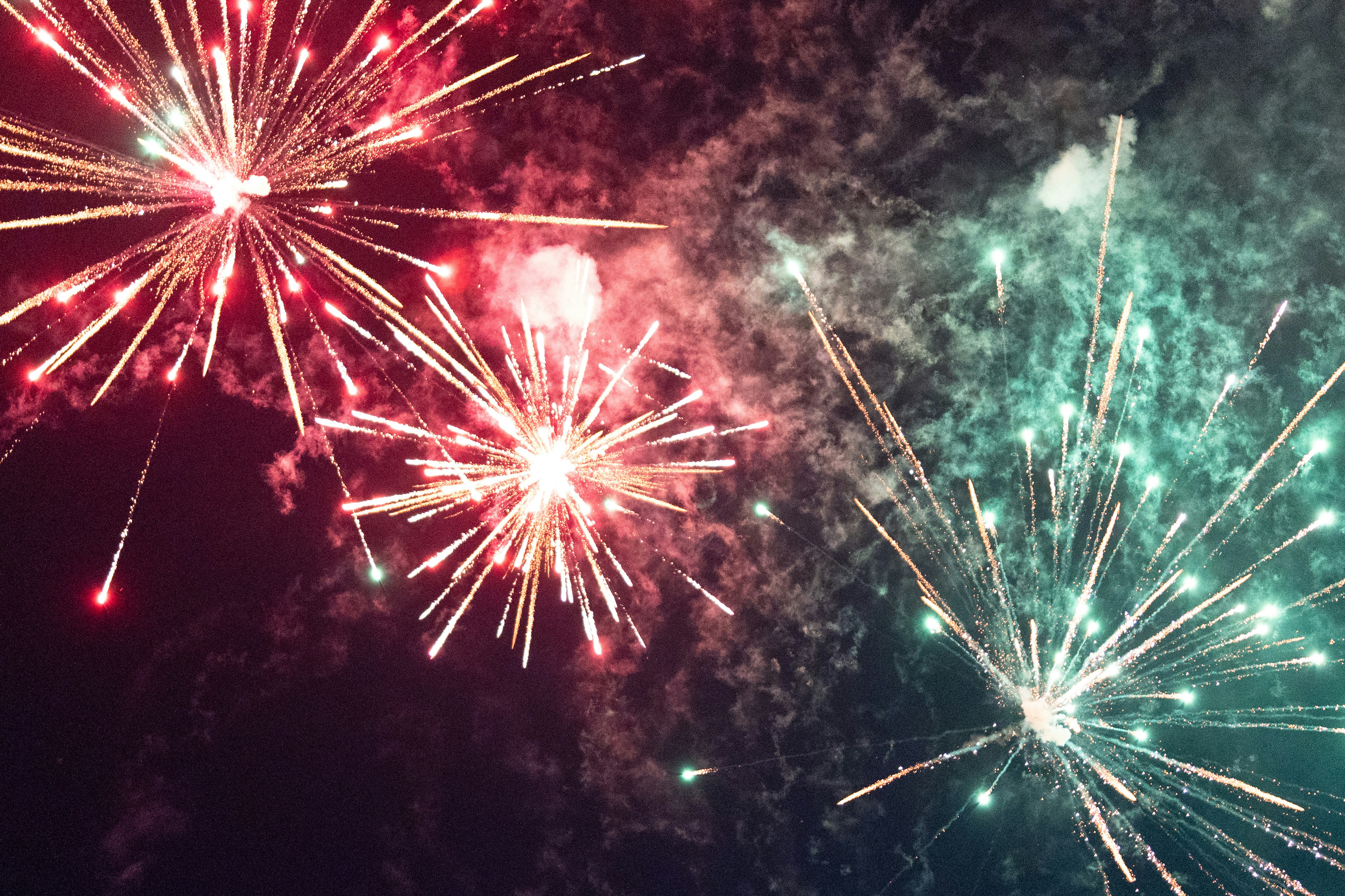 Skyburst in Neon Night: Multicolored Fireworks Over a Dark Canvas