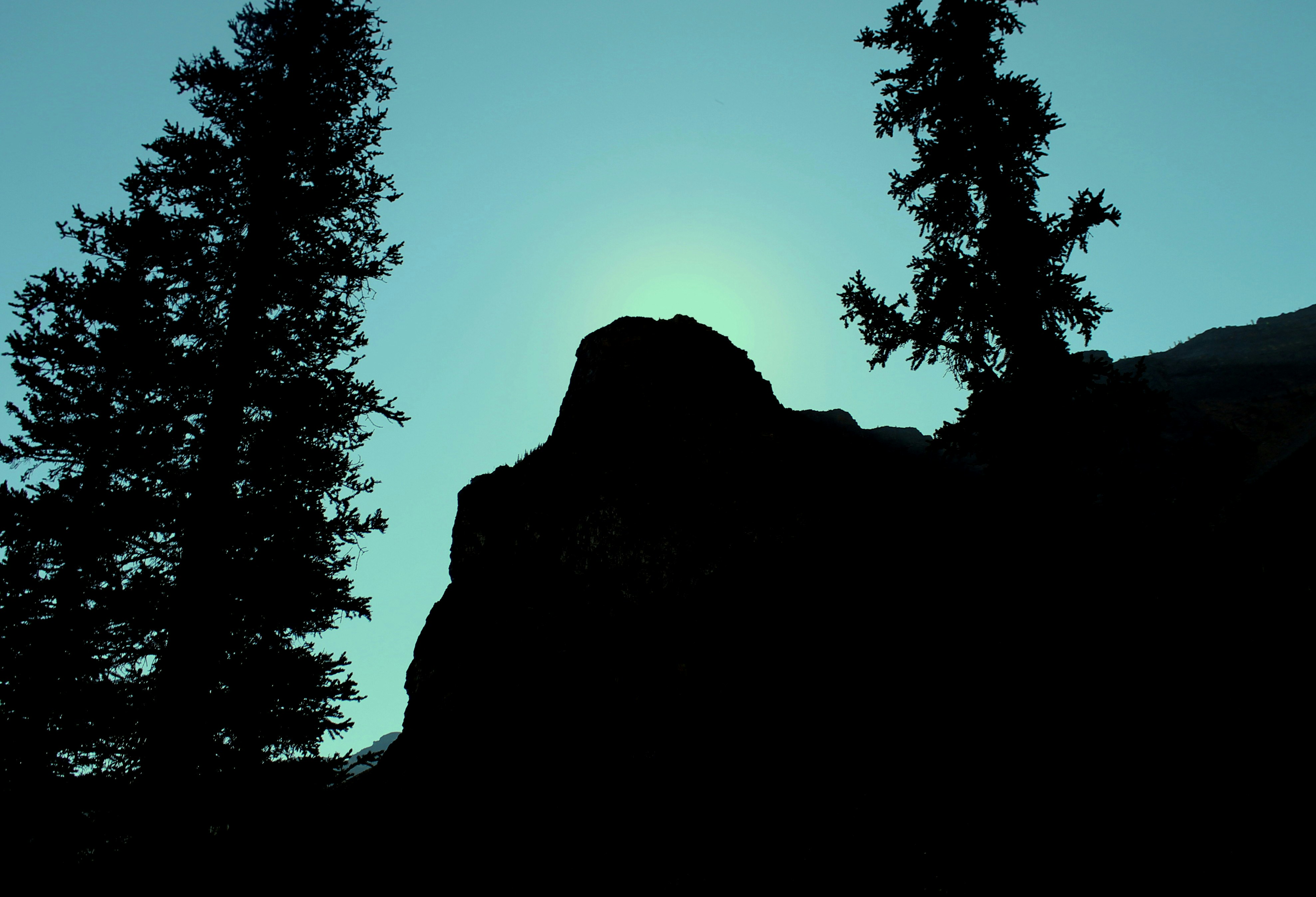 Silhouette Beyond the Summit at Dusk