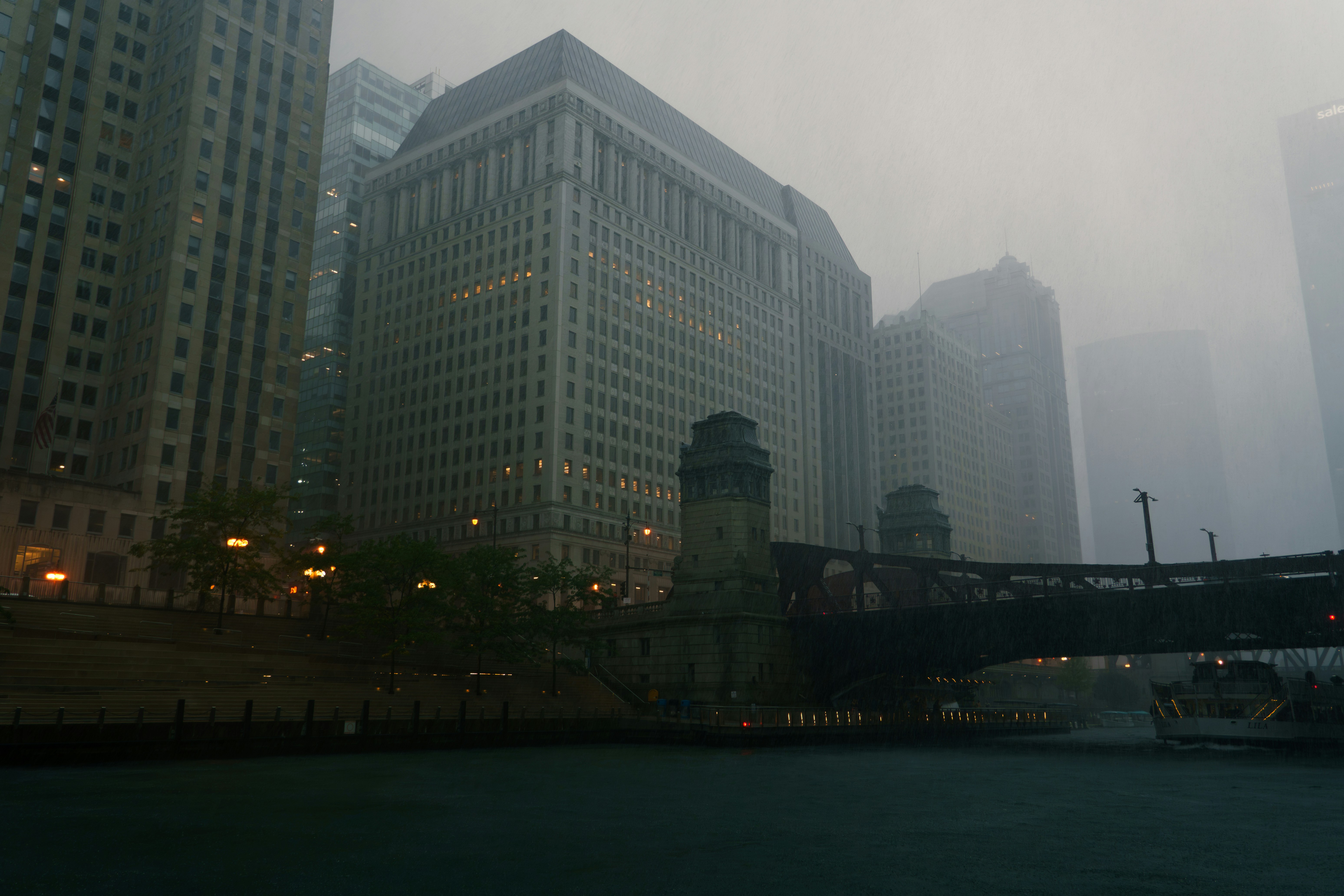 Foggy Chicago River Verge: Towers Loom Over Silent Waters