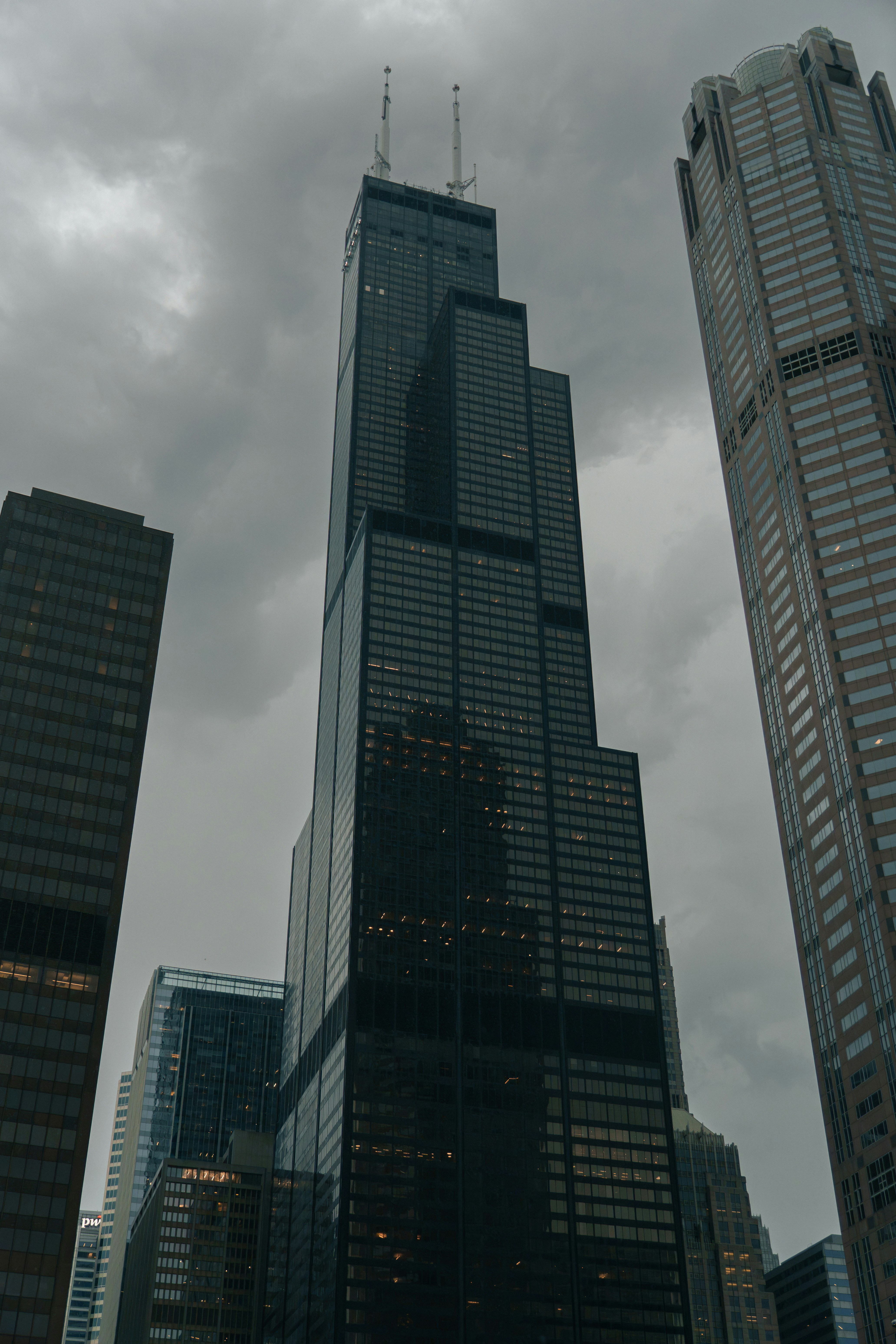 Towering Glass Pulse: A City Canyon Under Stormy Light