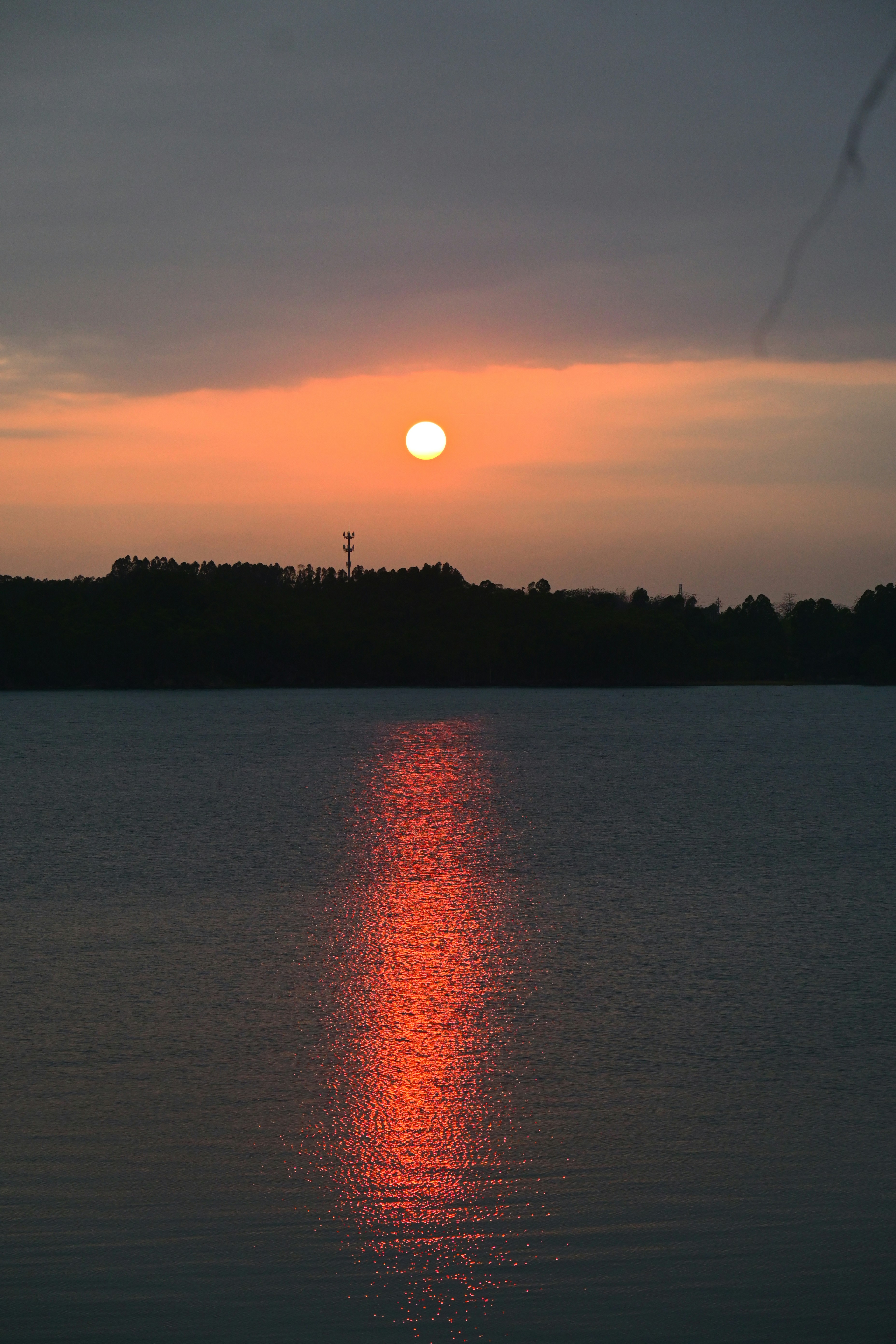 Sunlit Reflection: Quiet Sunset Over a Calm Lake