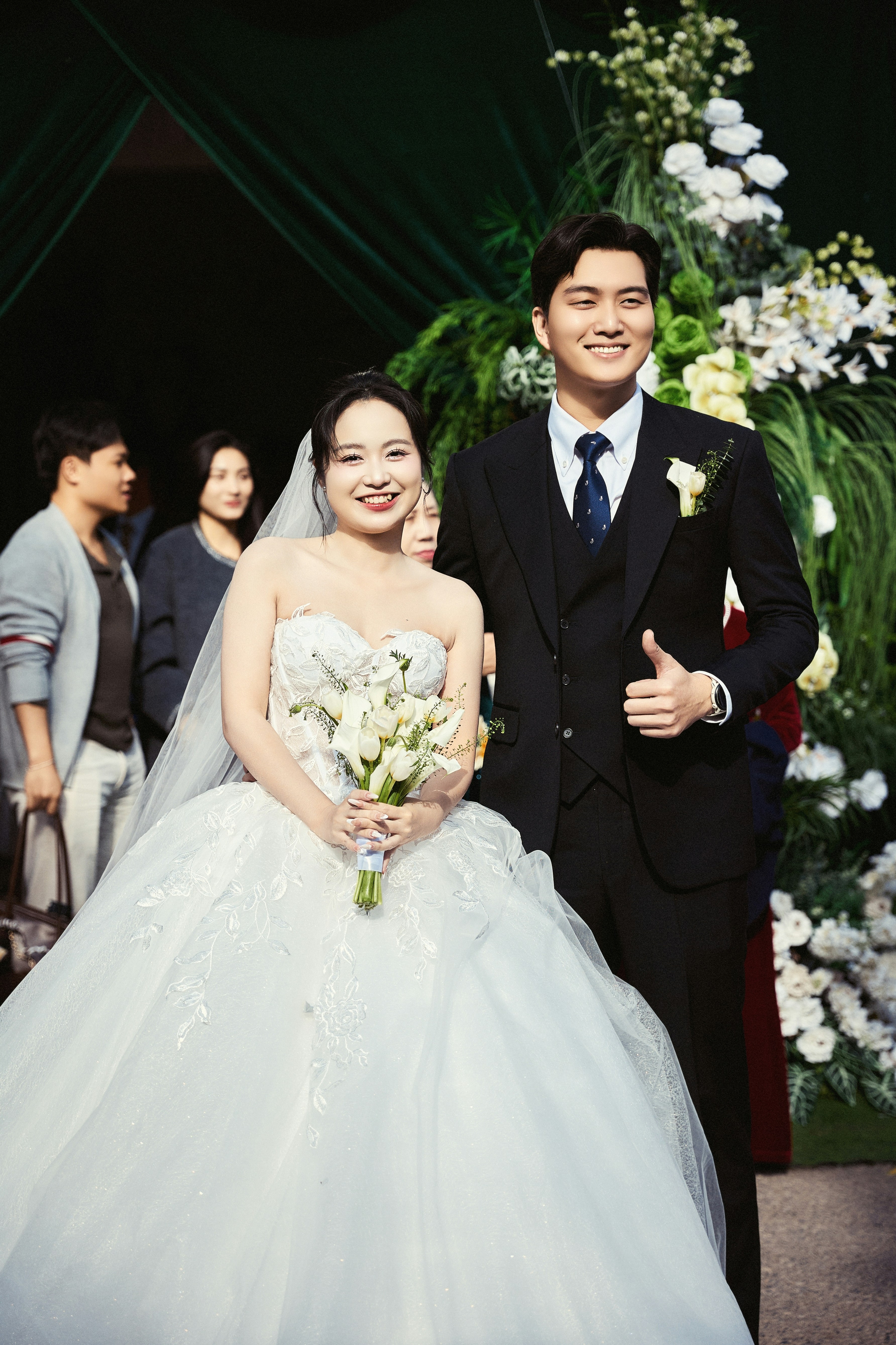 Joyous Newlyweds Pose Amid Floral Archway