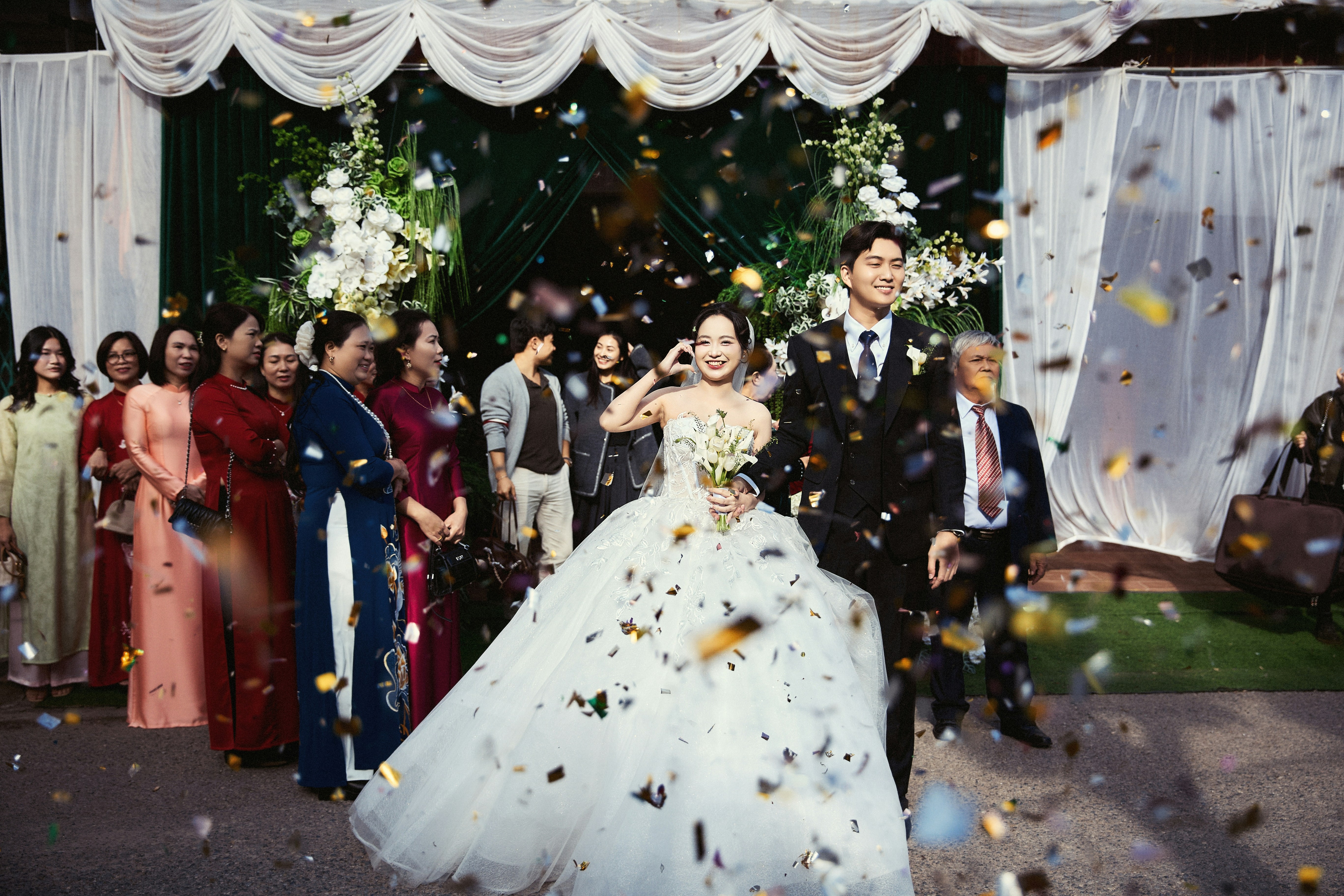 The Bride and Groom Lead a Confetti Boom Down the Aisle