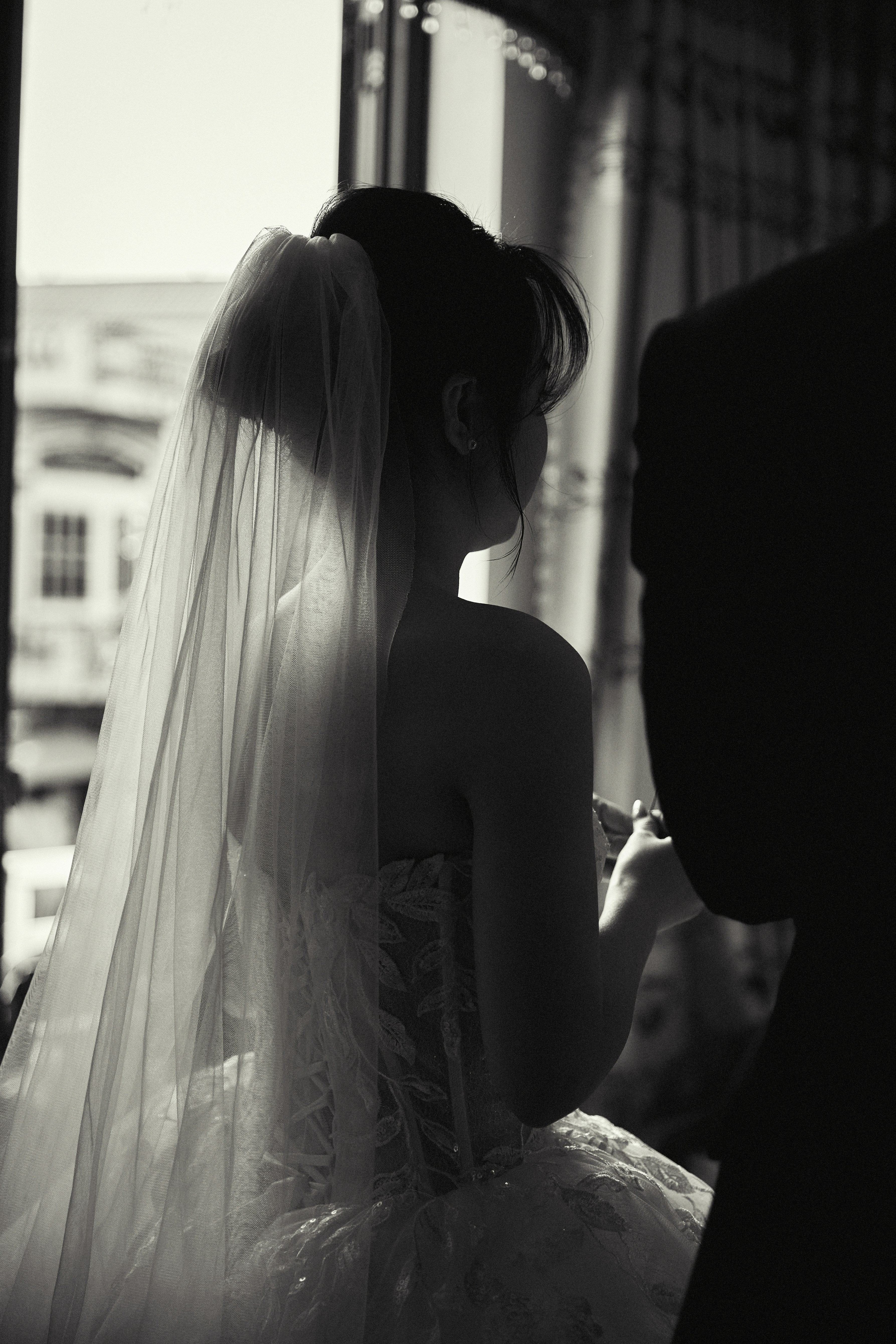 Bride in silhouette: quiet vow by the window