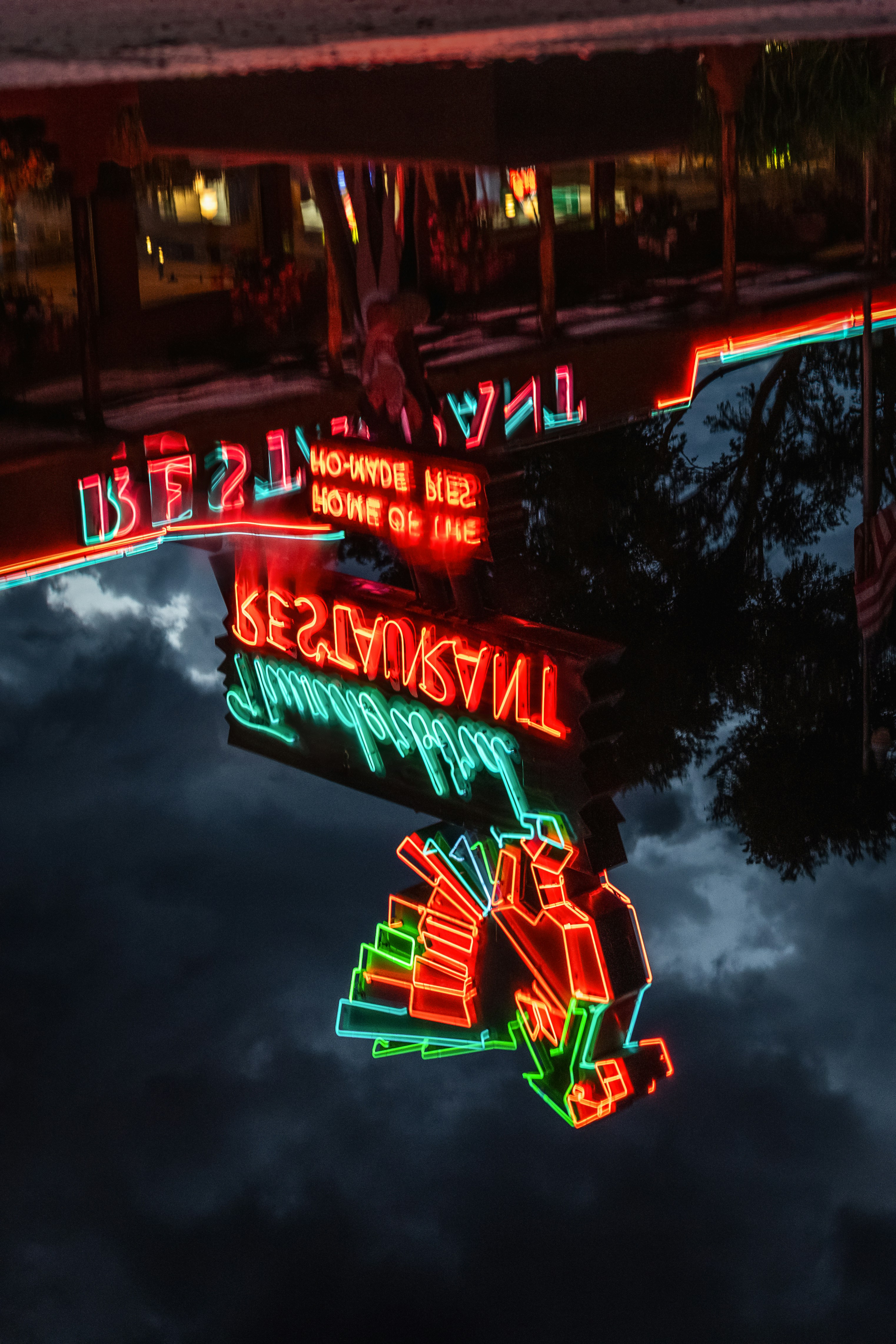 Neon Reflections: A City Sign Reimagined in Twilight