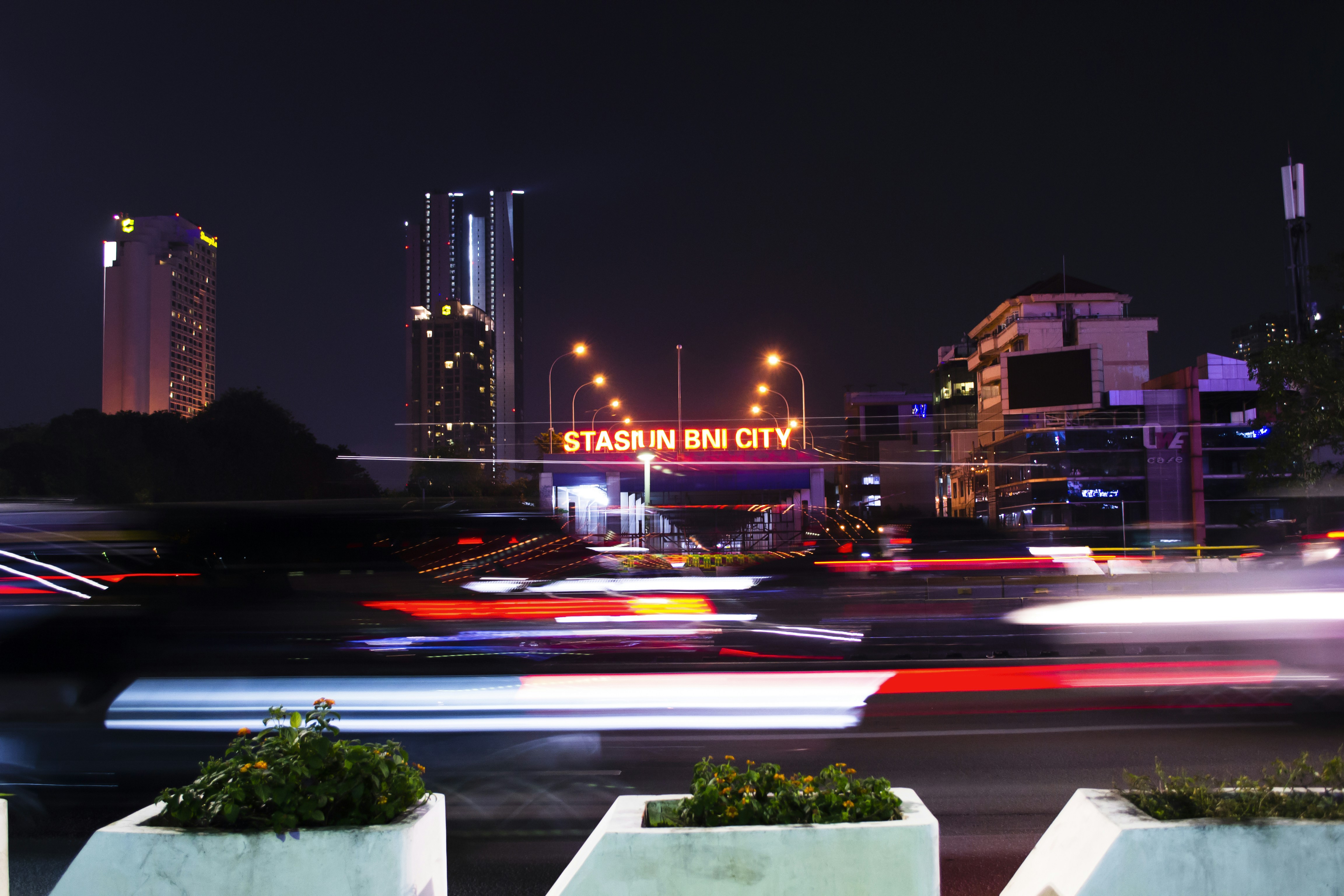 Neon Streaks over a Quiet Riverside Crossroad