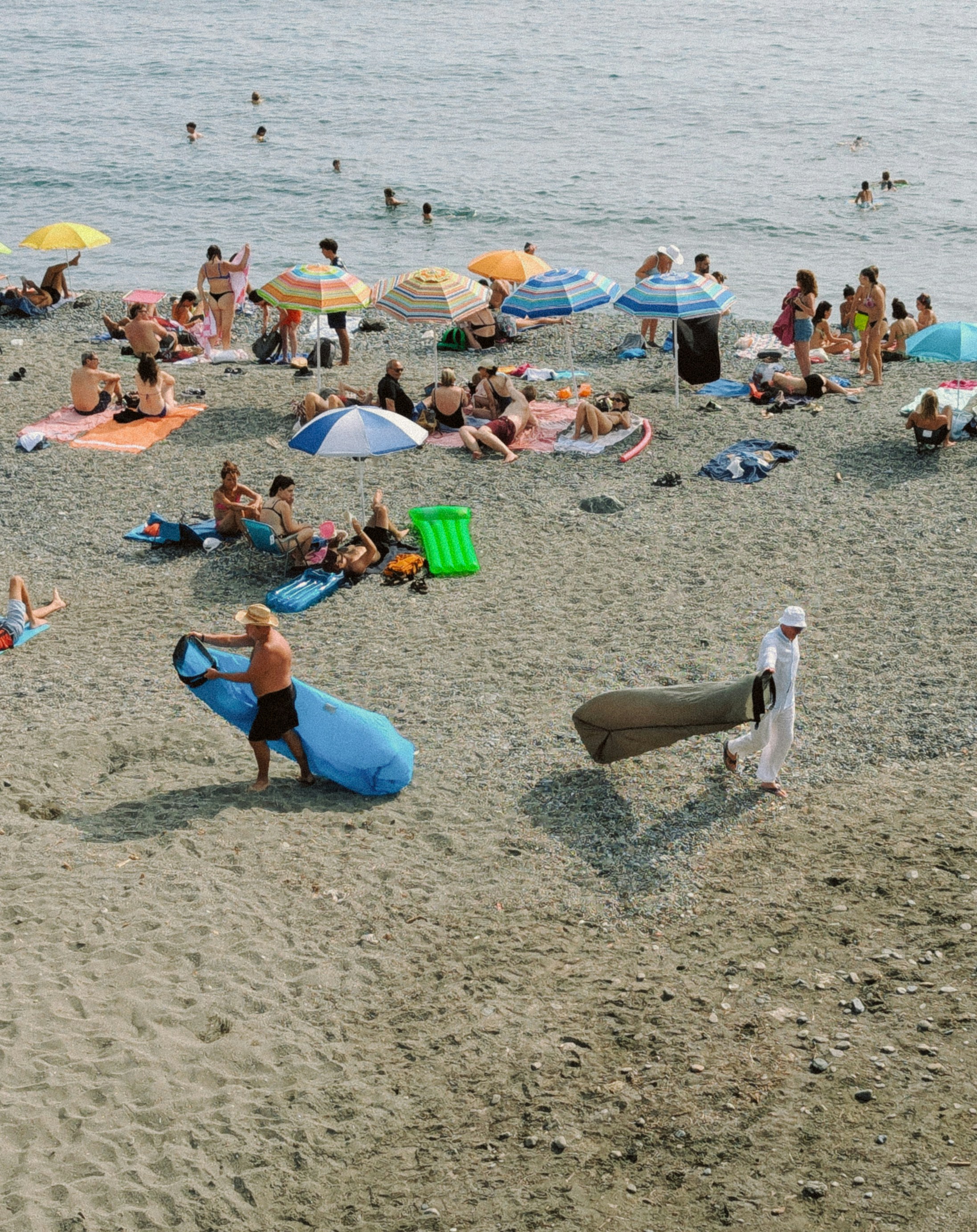 Sunbathers, Umbrellas, and a Seaside Lifeguard in Transition Light