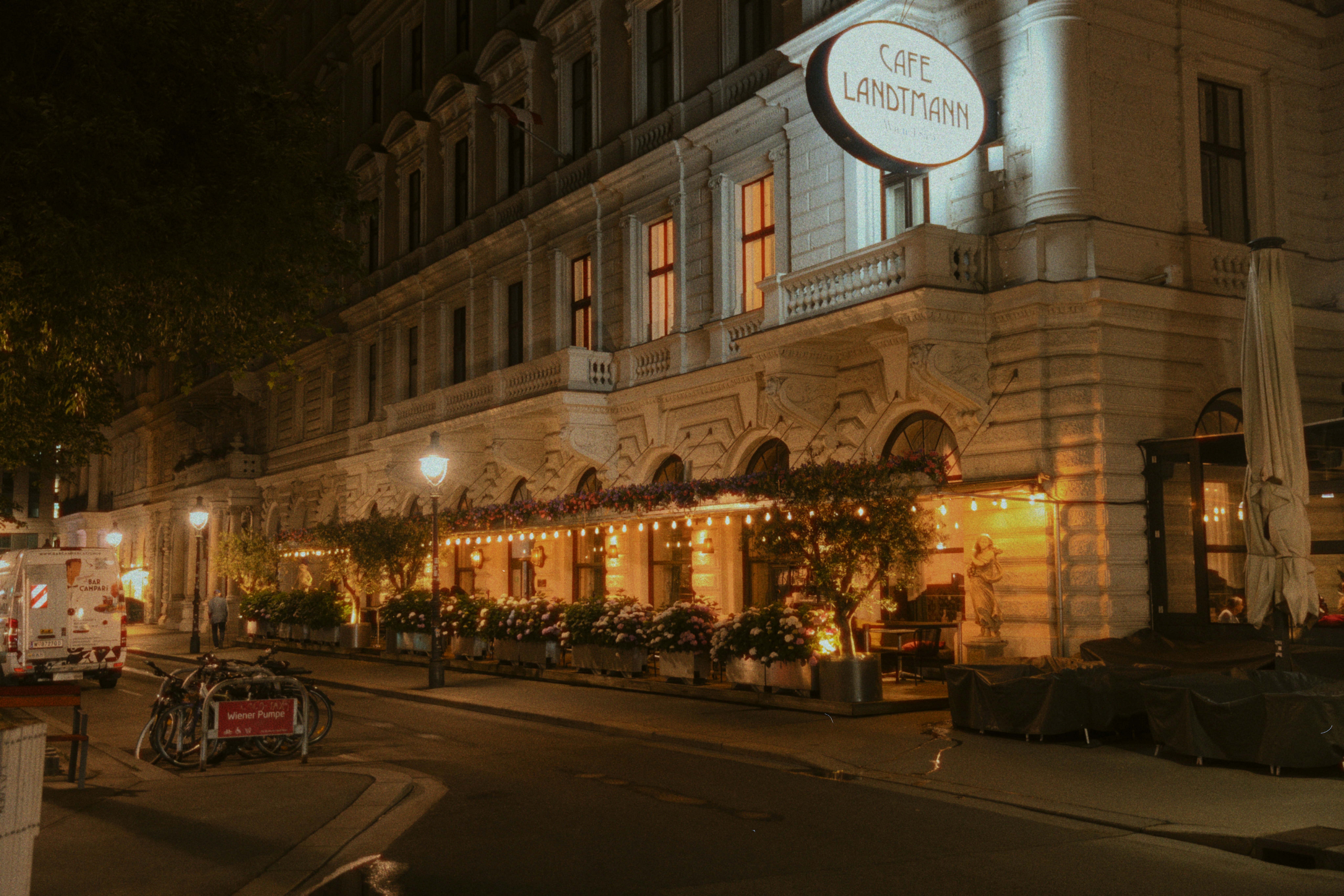 Night at Café Landtmann: Warm Glow on Sauntering Viennese Street