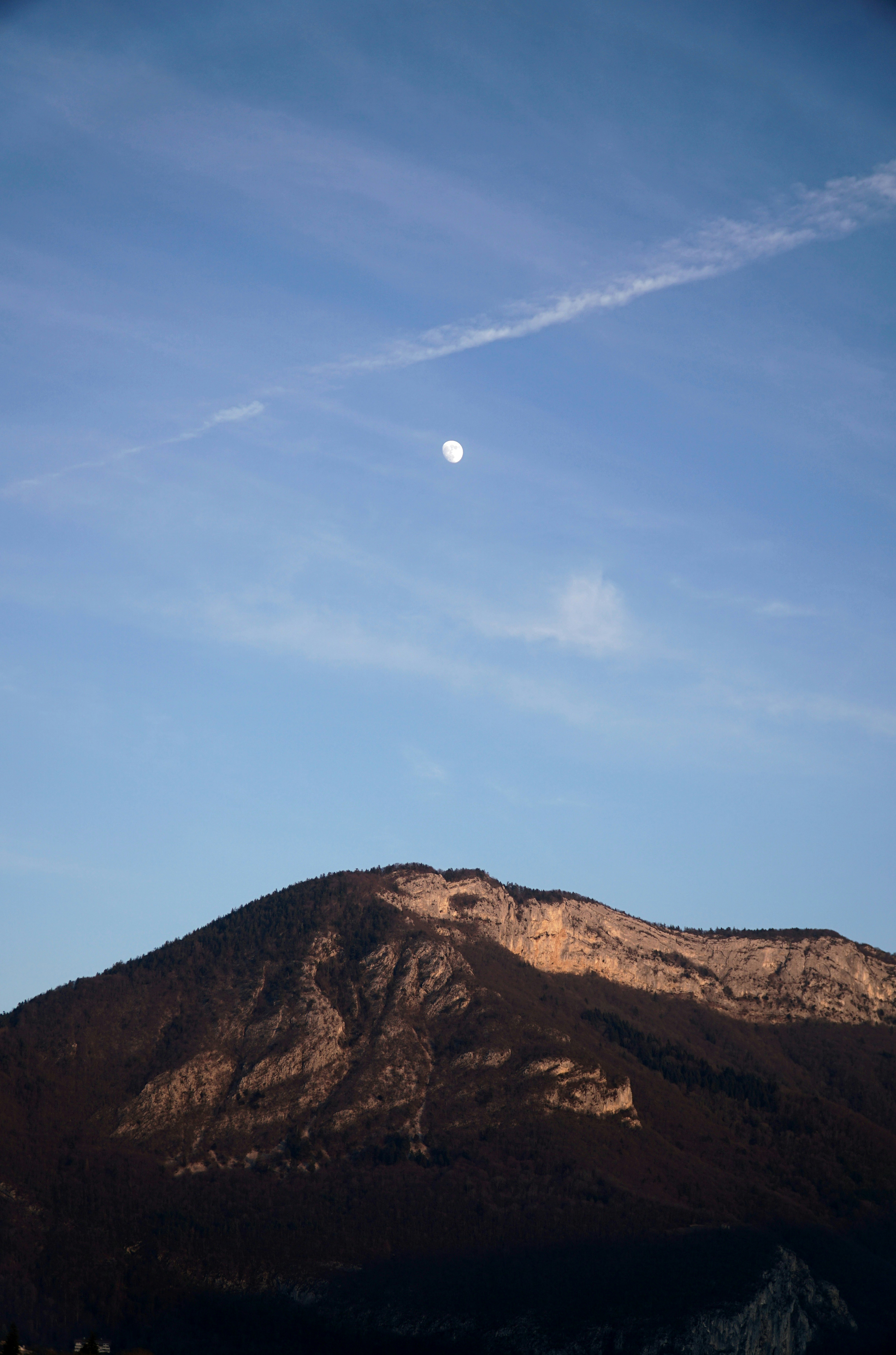 Moon over the rugged ridge at golden hour
