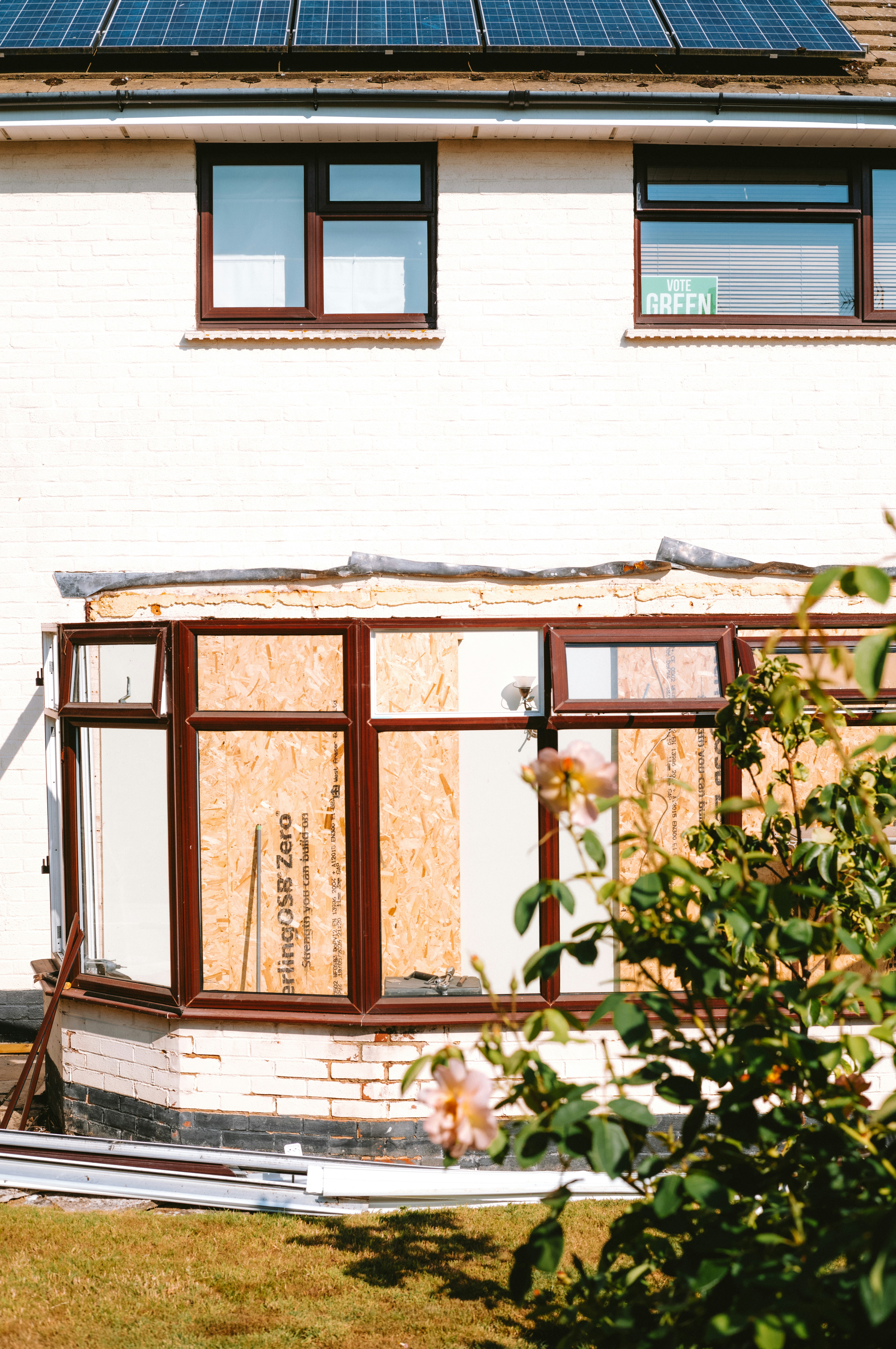 Sunlit Renovation: A White Brick House Gathers Moss and Roses