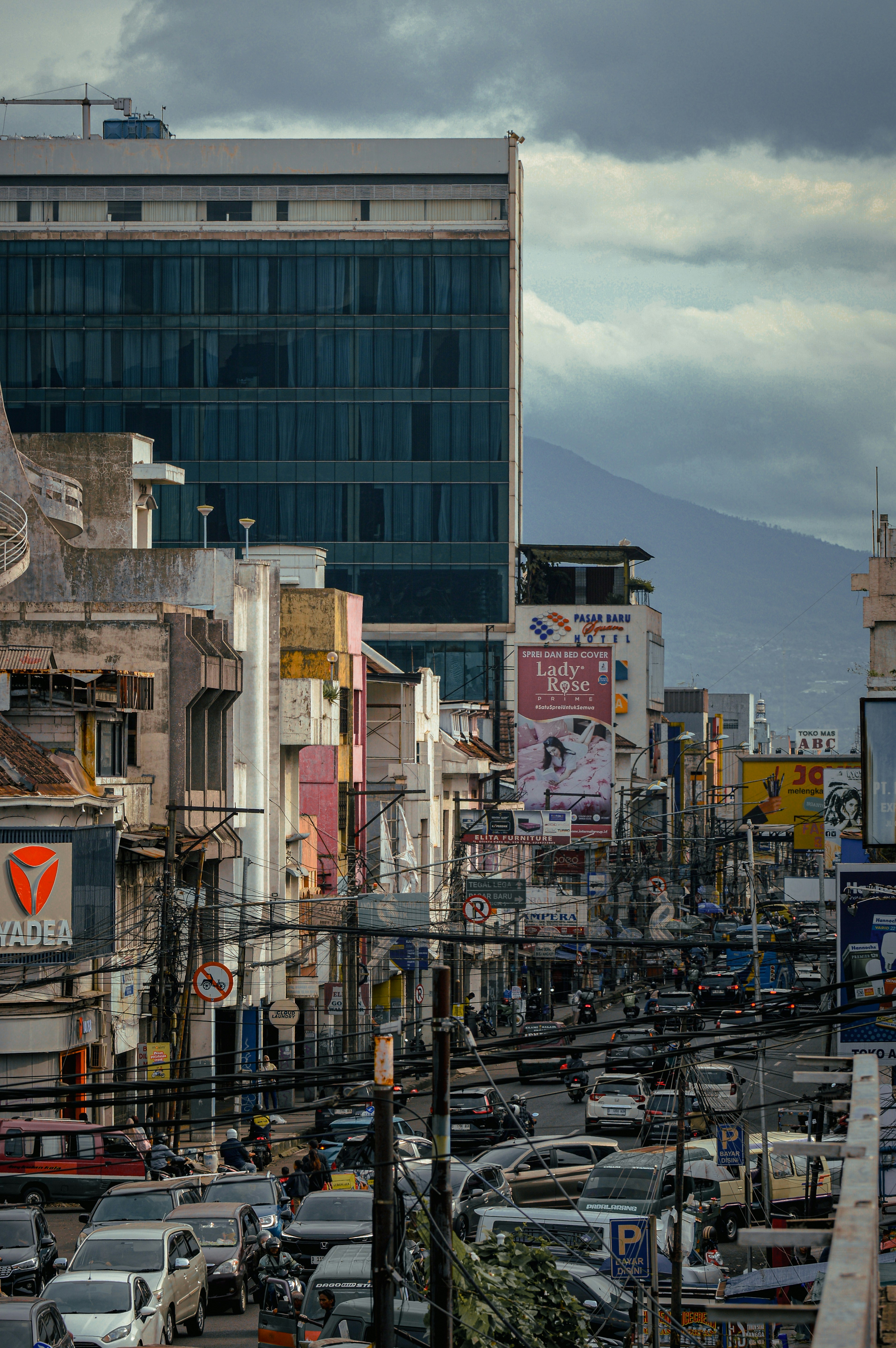 Urban Pulse: Neon Signs and Mountain Backdrop Courting the Street