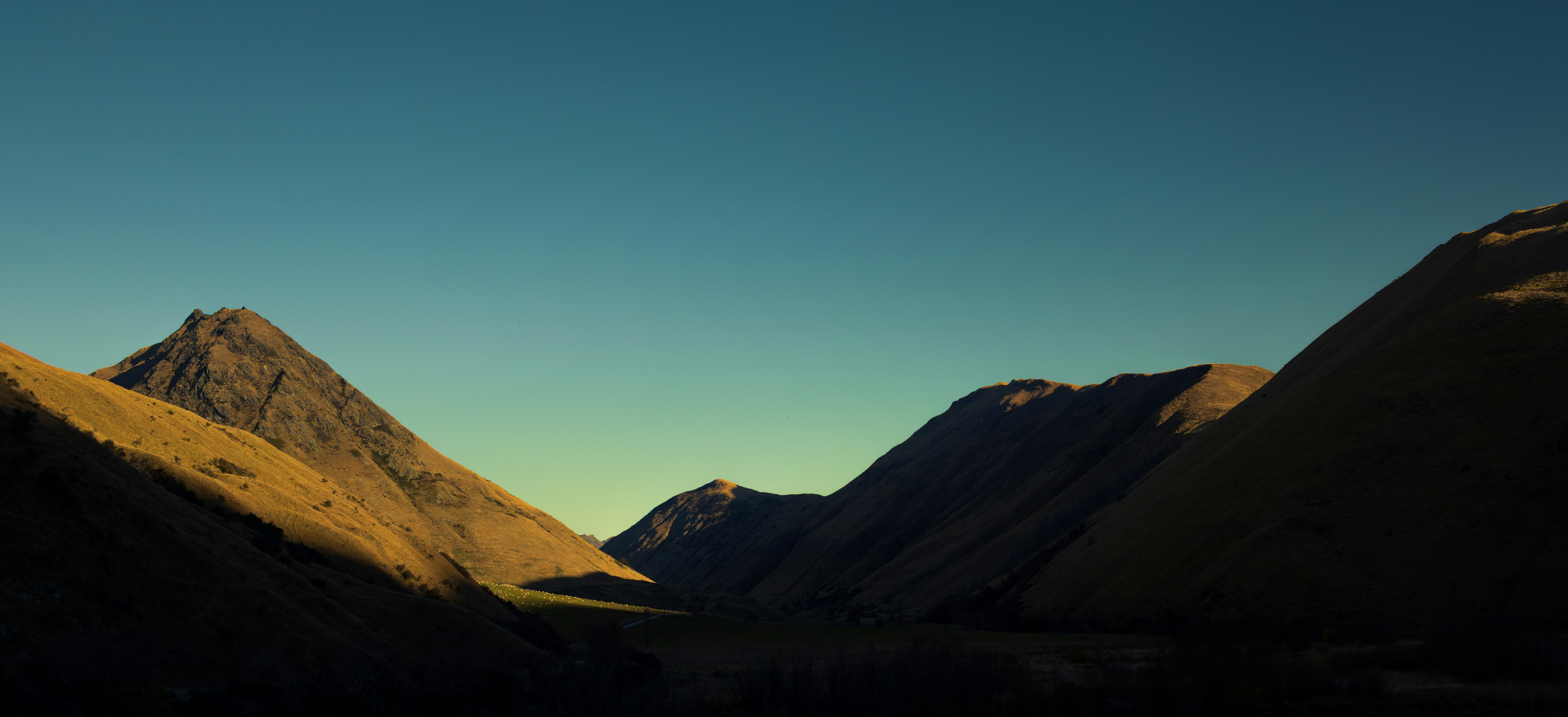 Dawn Over the Valley: Sunlit Peaks in Quiet Light