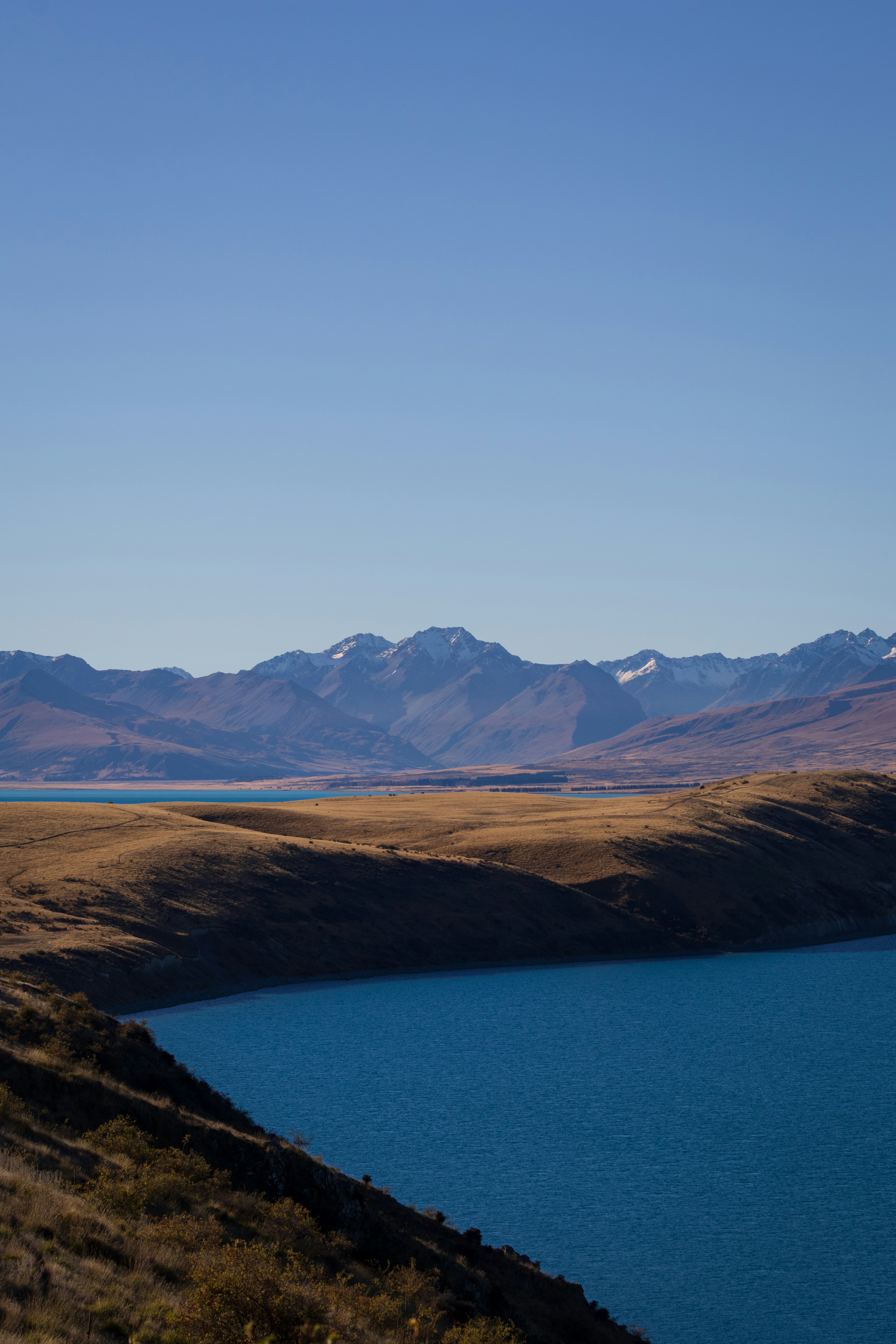 Blue Basin Between Snow-Tipped Peaks