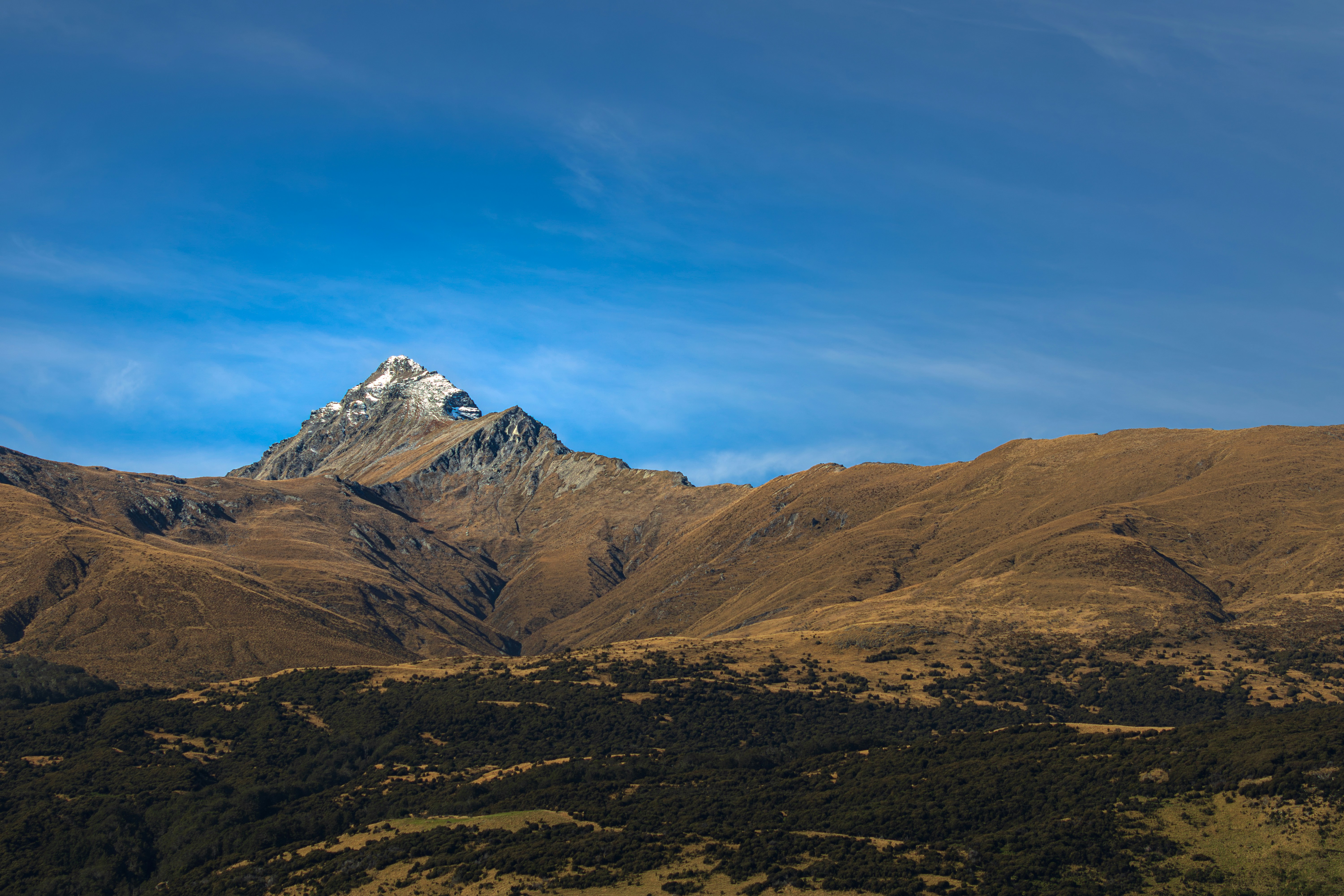 Snow-capped Peak Rising Above Golden Hills