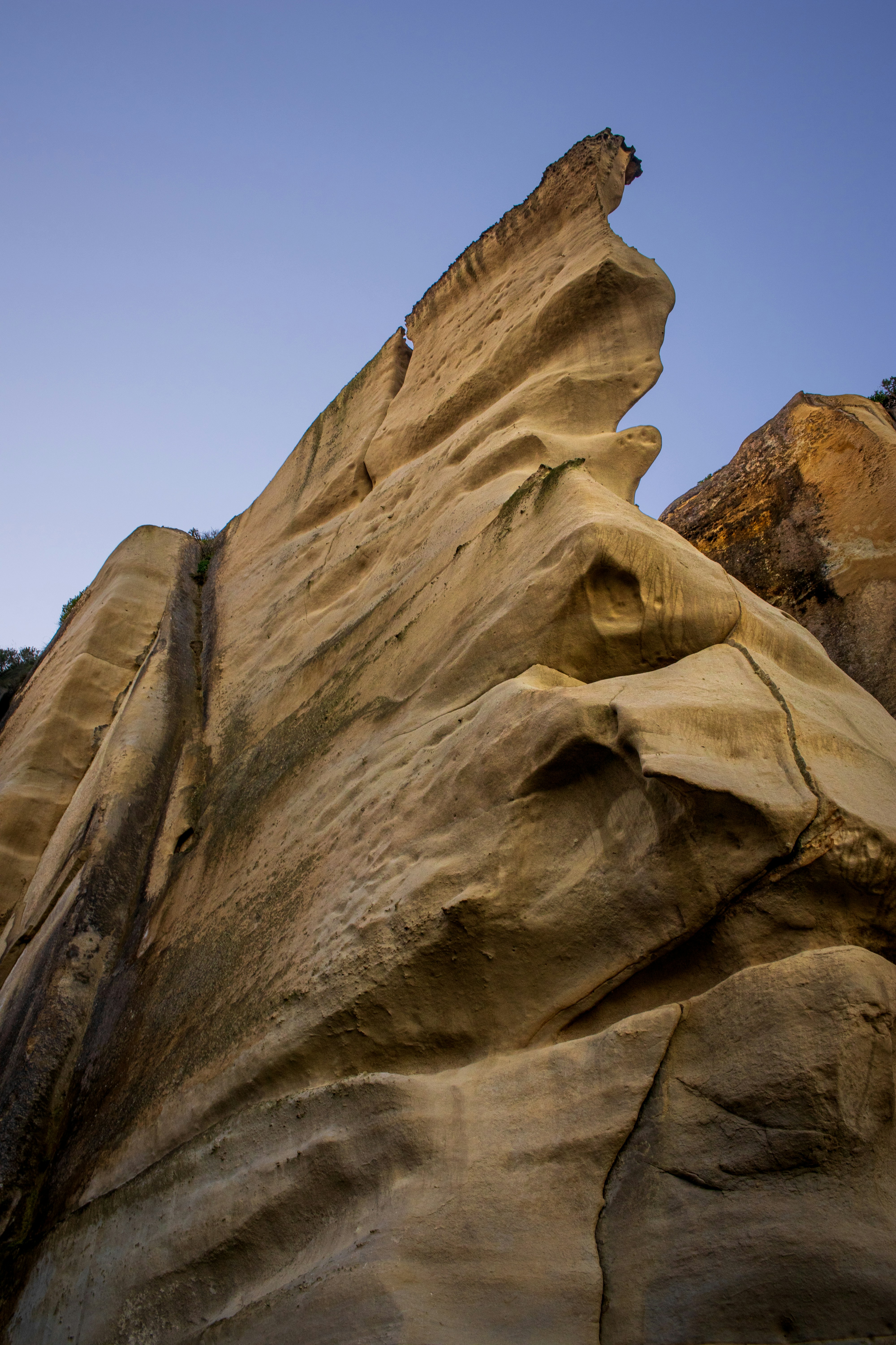 Wind-carved Sentinel: A sandstone pinnacle rising against a clear blue sky