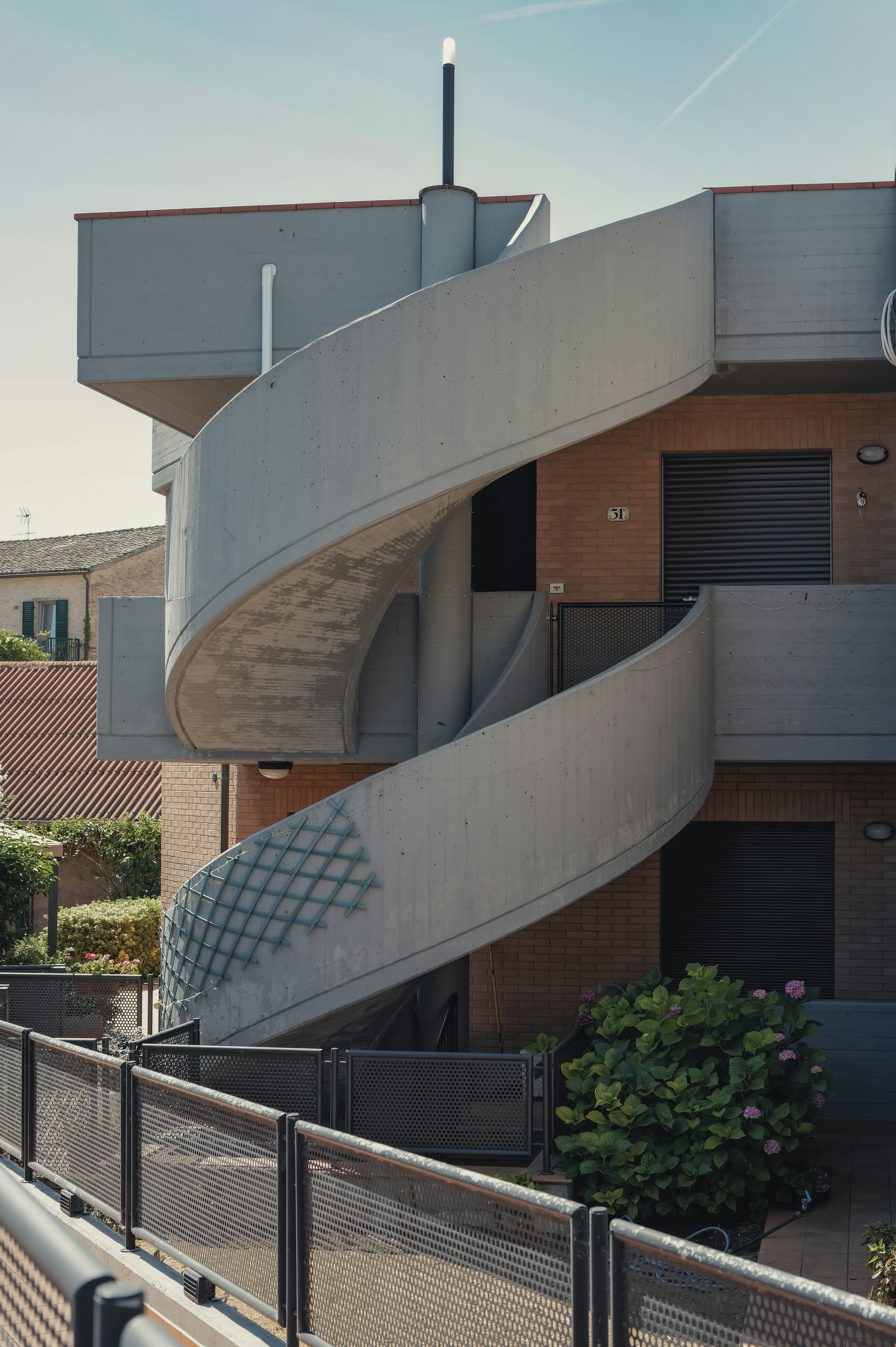 Curved Concrete Spine: A Spiraling Staircase Cloaked in Shadow