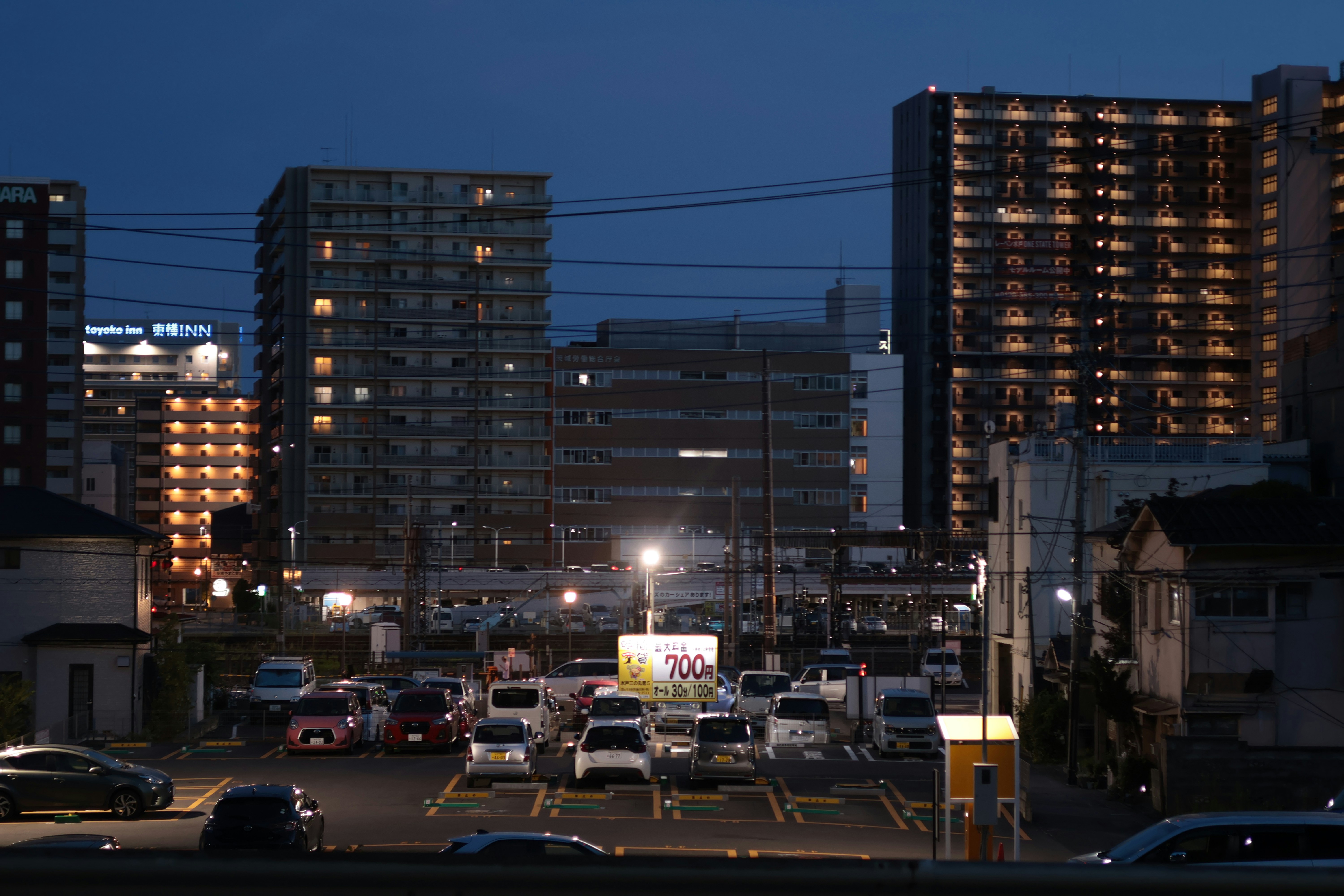 Evening Flow: City Street Rush Beneath Tall Apartment Blocks