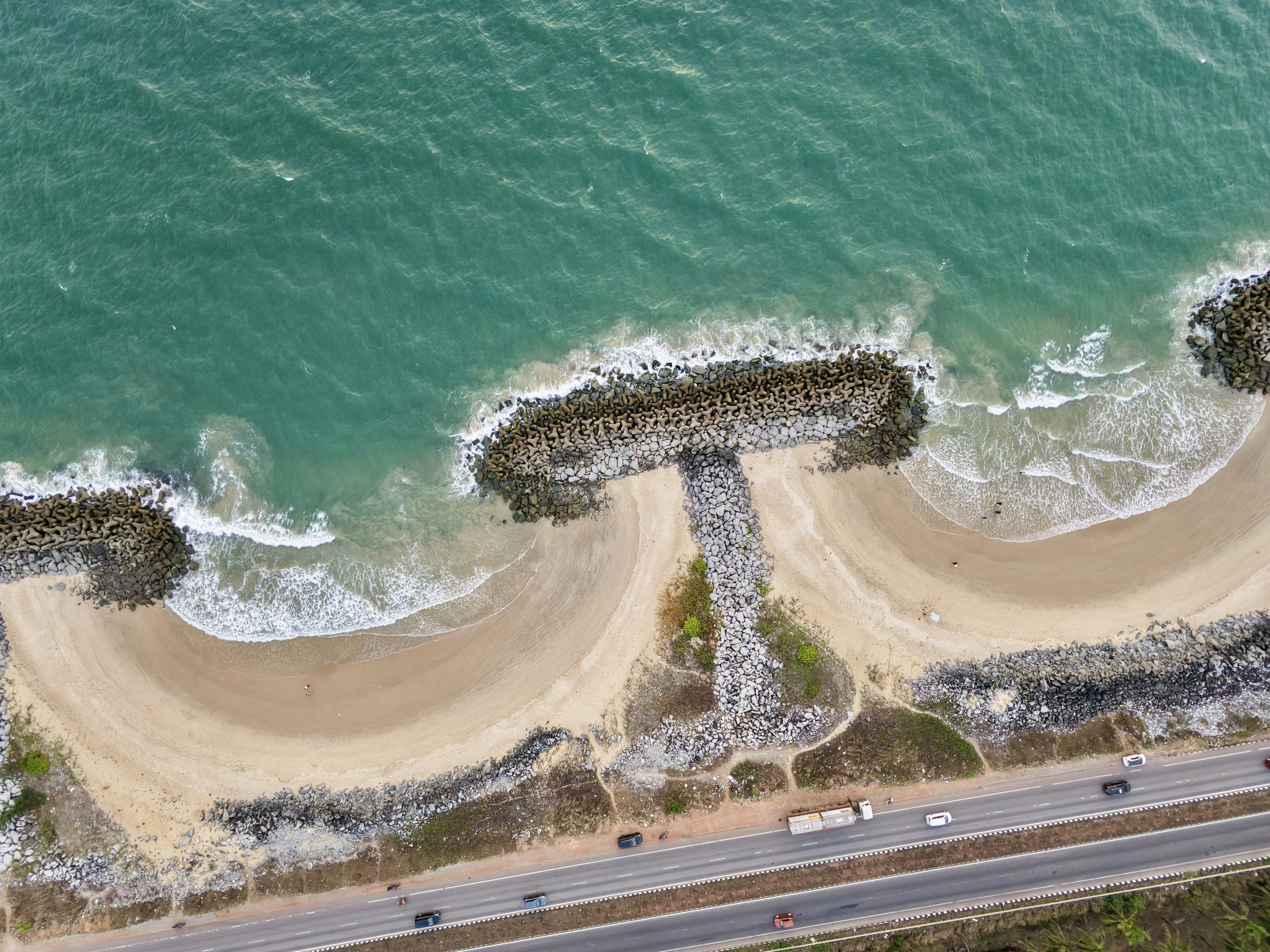 Coastal Tidal Path: Aerial View of Beach, Breakwater, and Seafront Road