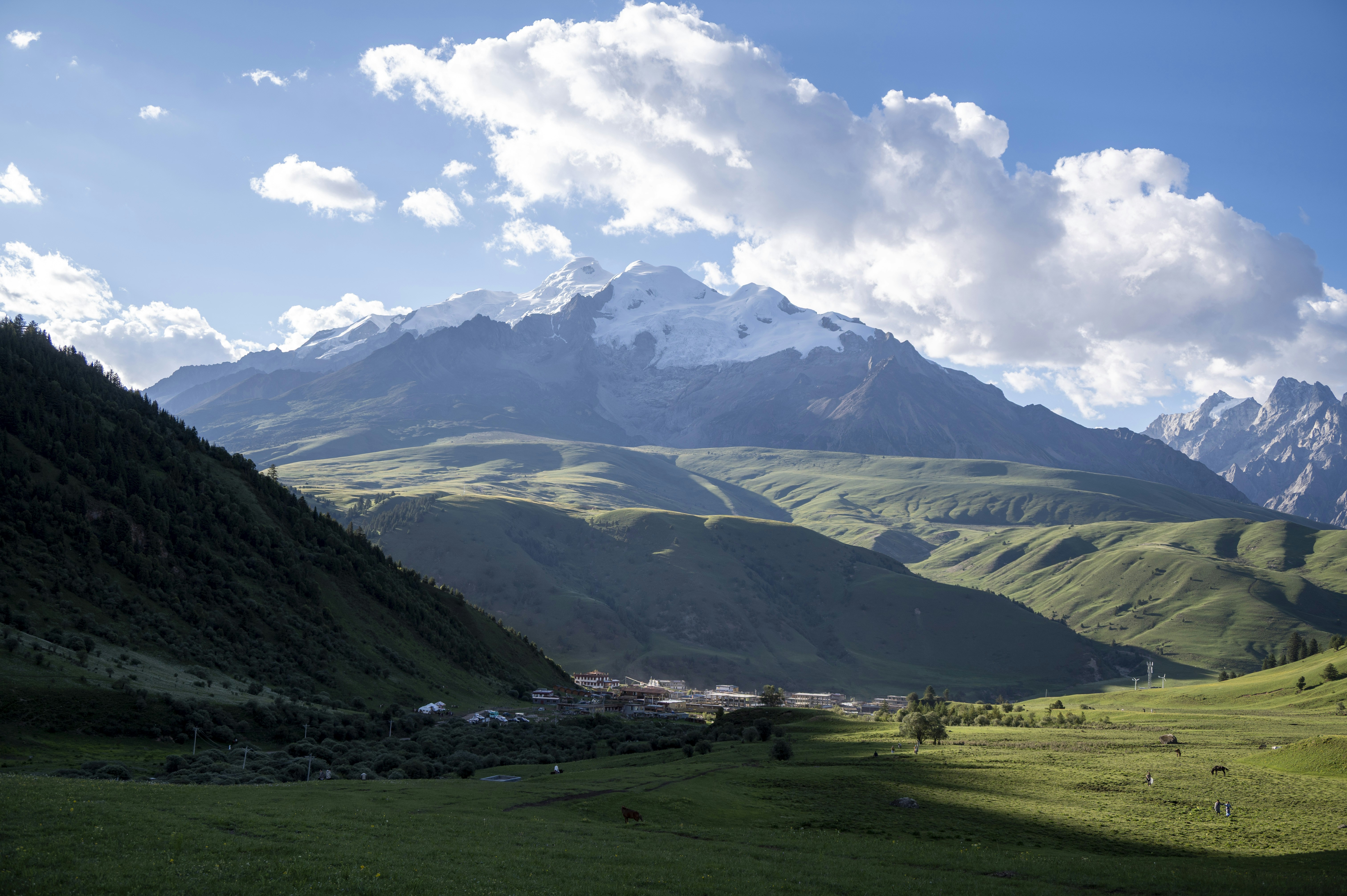 Emerald Valleys and Snow-Capped Peaks Under a Bright Skies