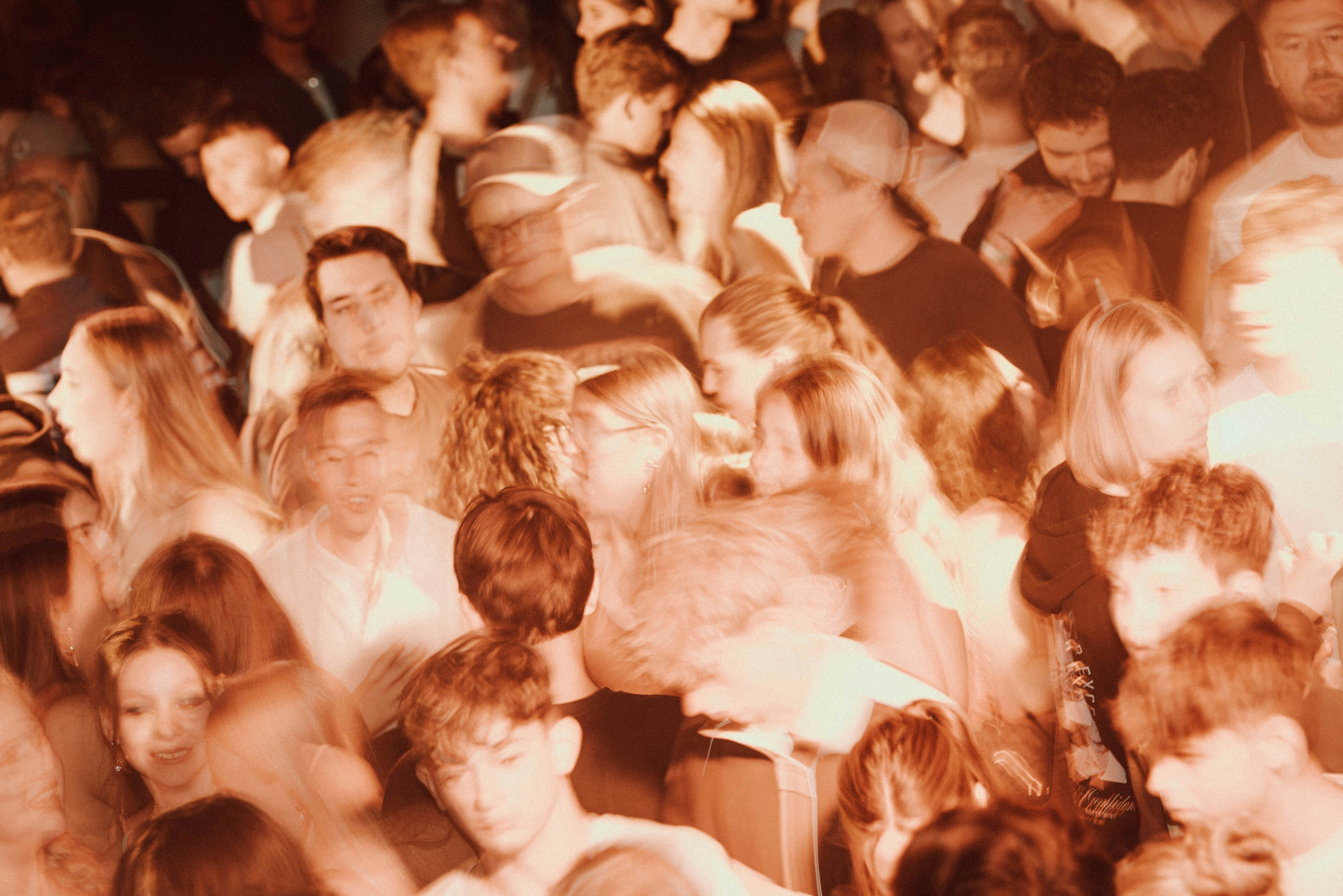 Midnight Pulse: A Sea of Faces in Warm Club Light