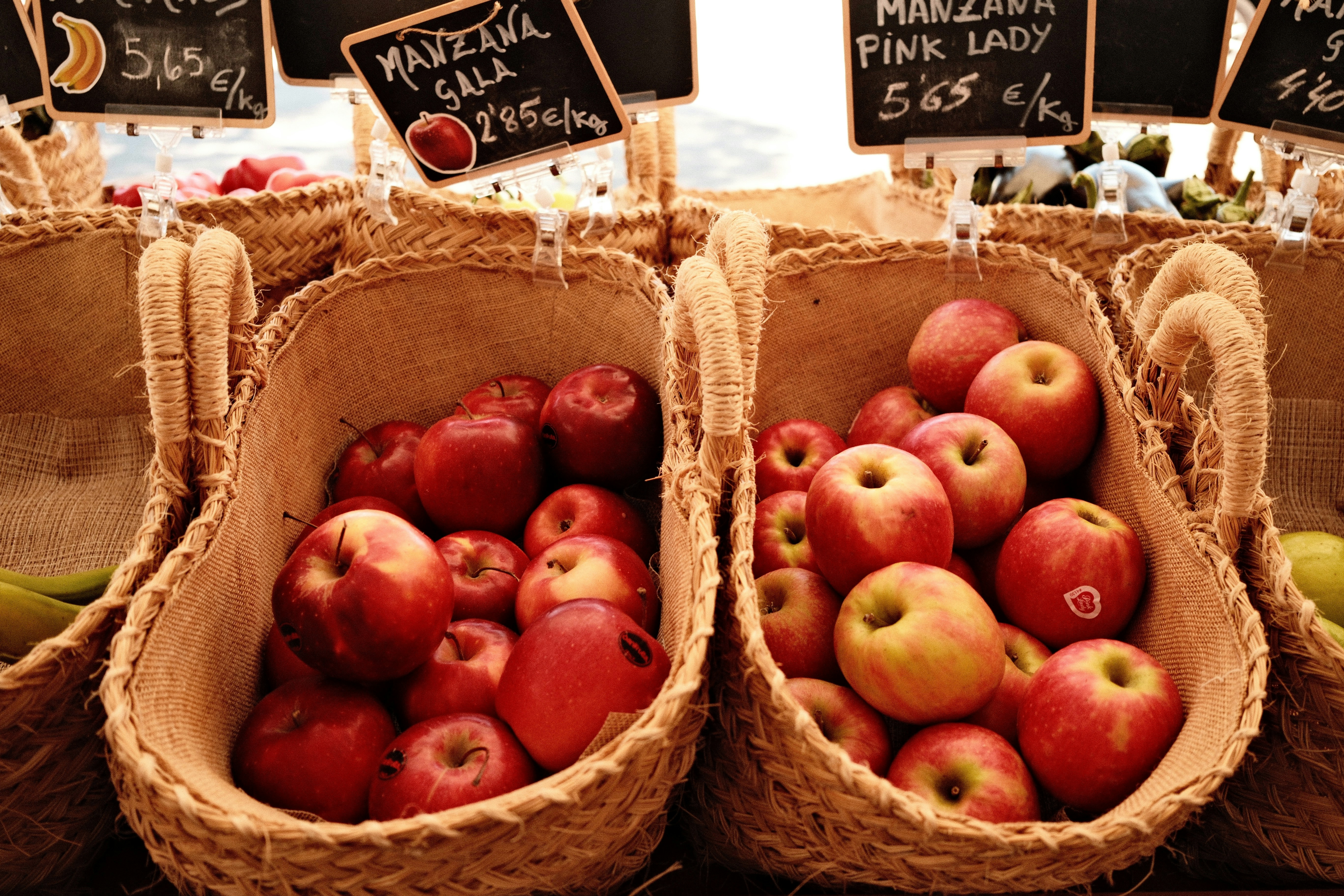 Harvested Reds: Apples in Sunlit Baskets at Market