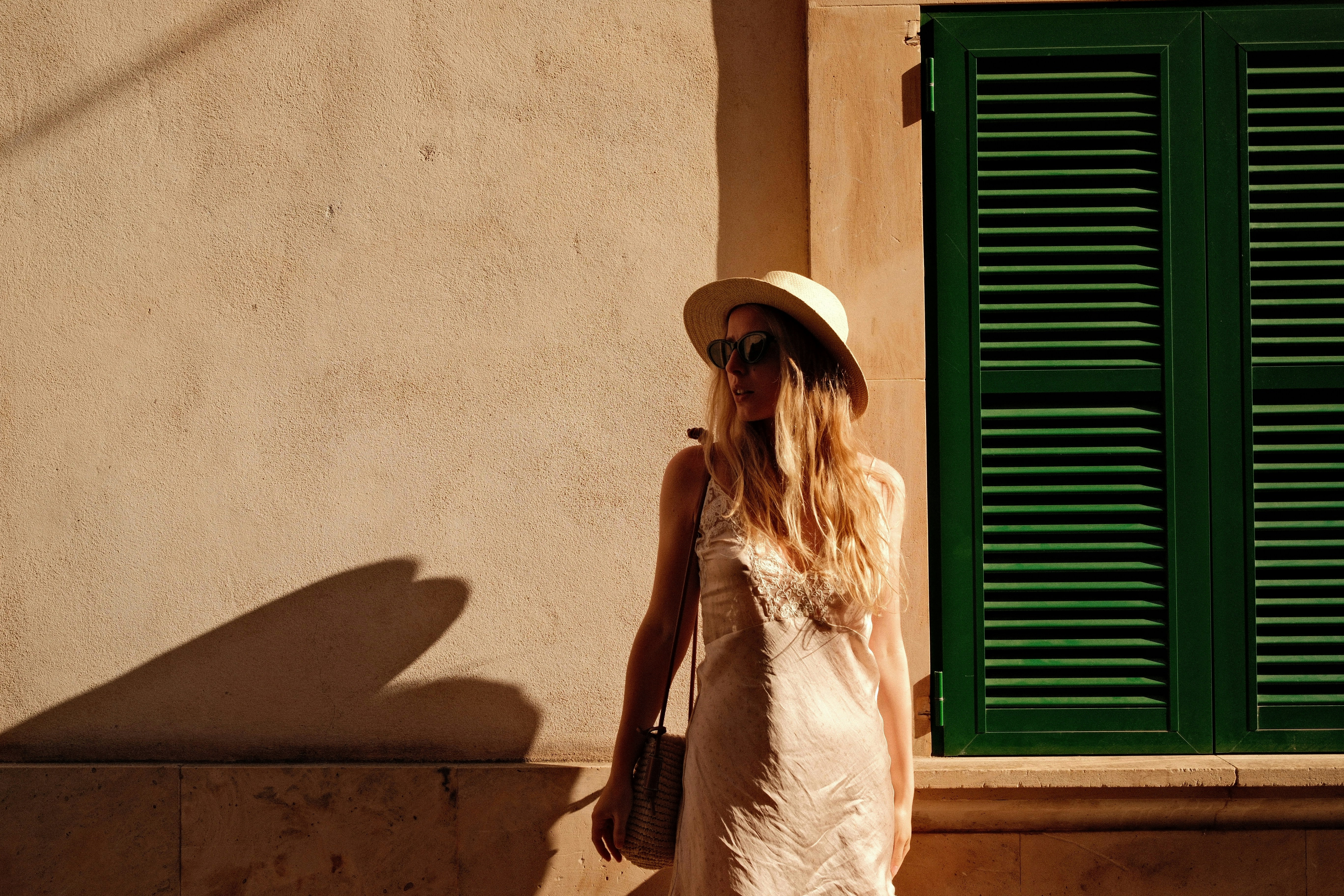 Sunlit Silhouette: Woman in a Linen Dress by Green Shutter