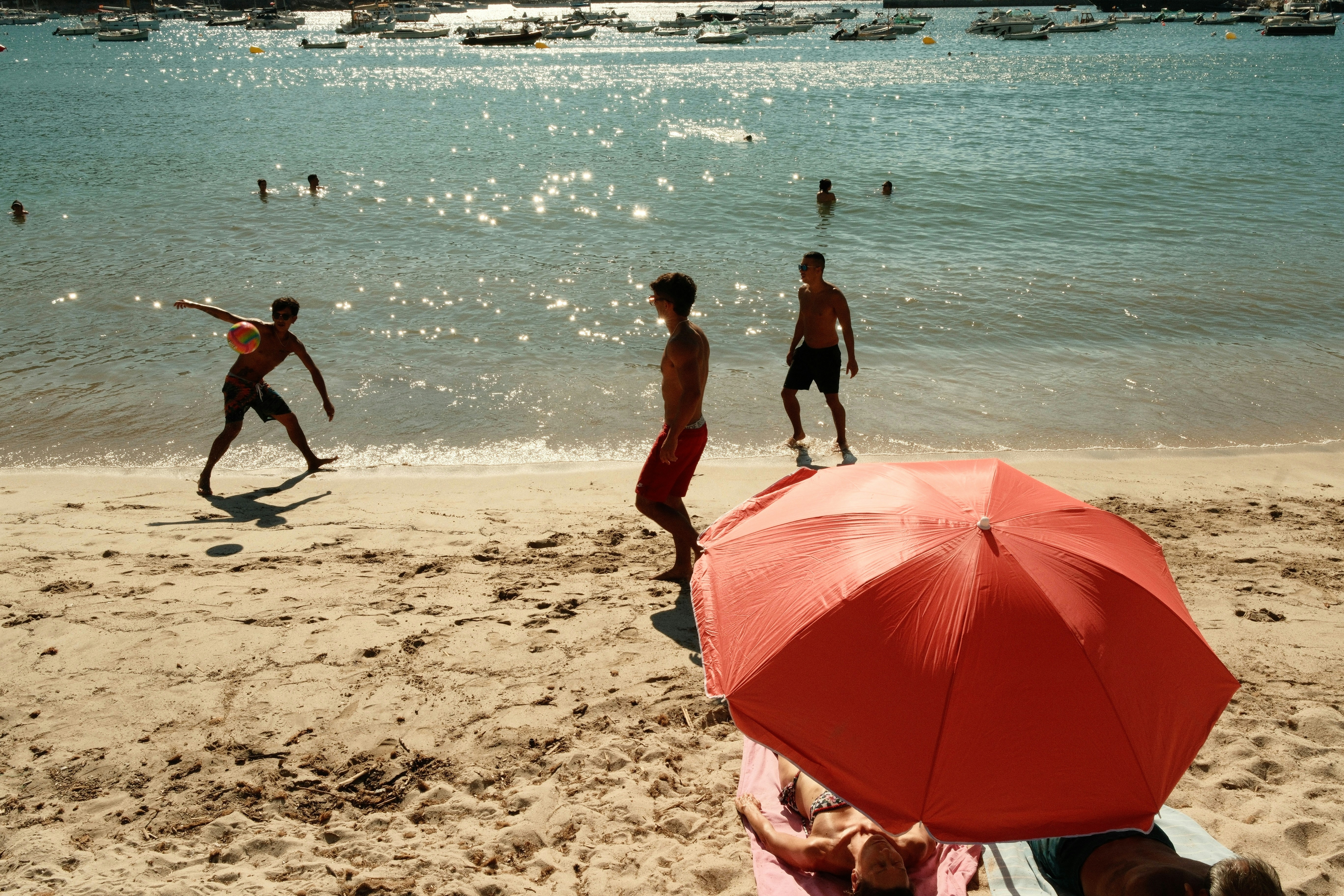 Sunlit Beach Montage: Kids at Play by a Scarlet Umbrella