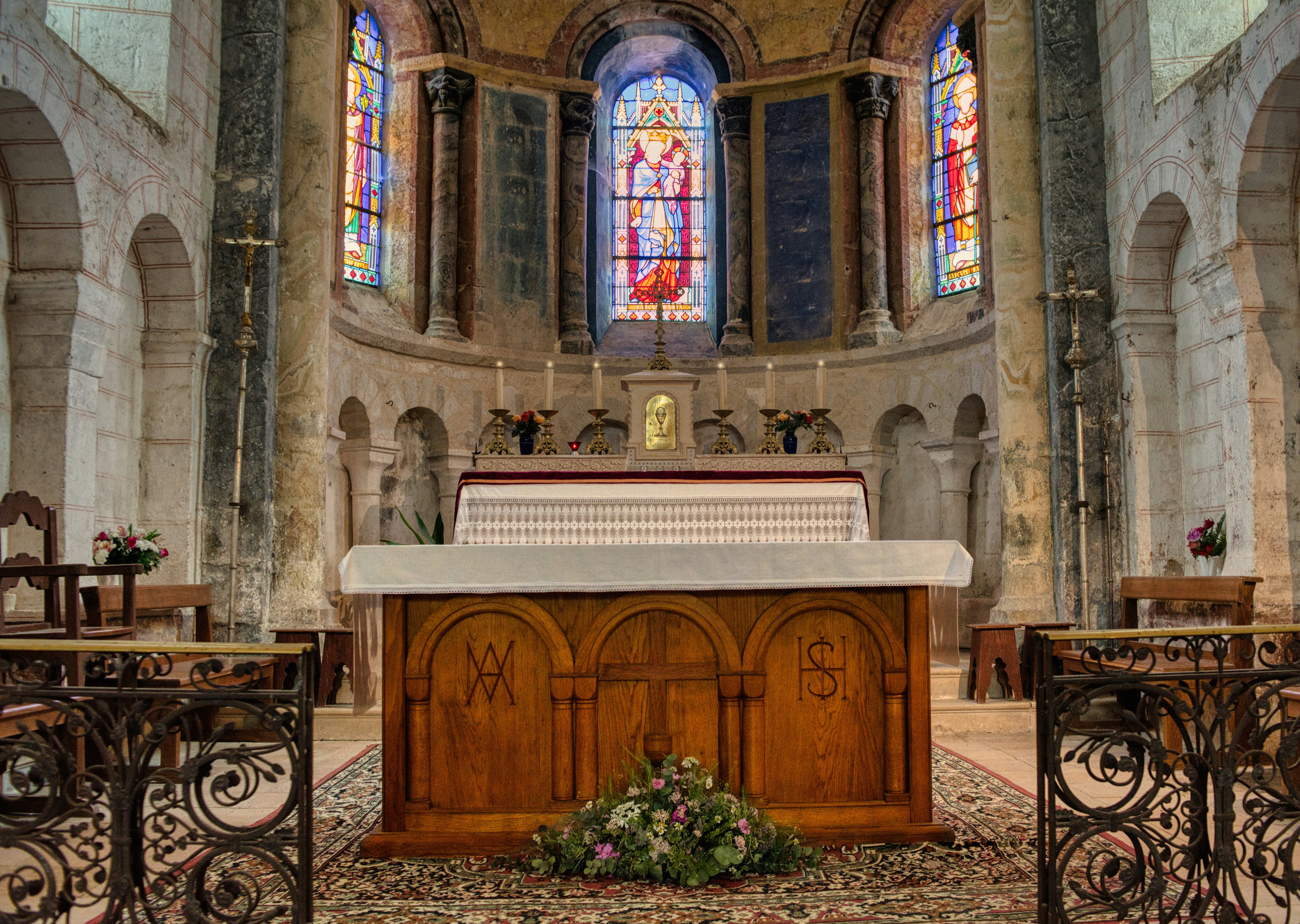 Resplendent altar framed by stained glass in a sacred nave