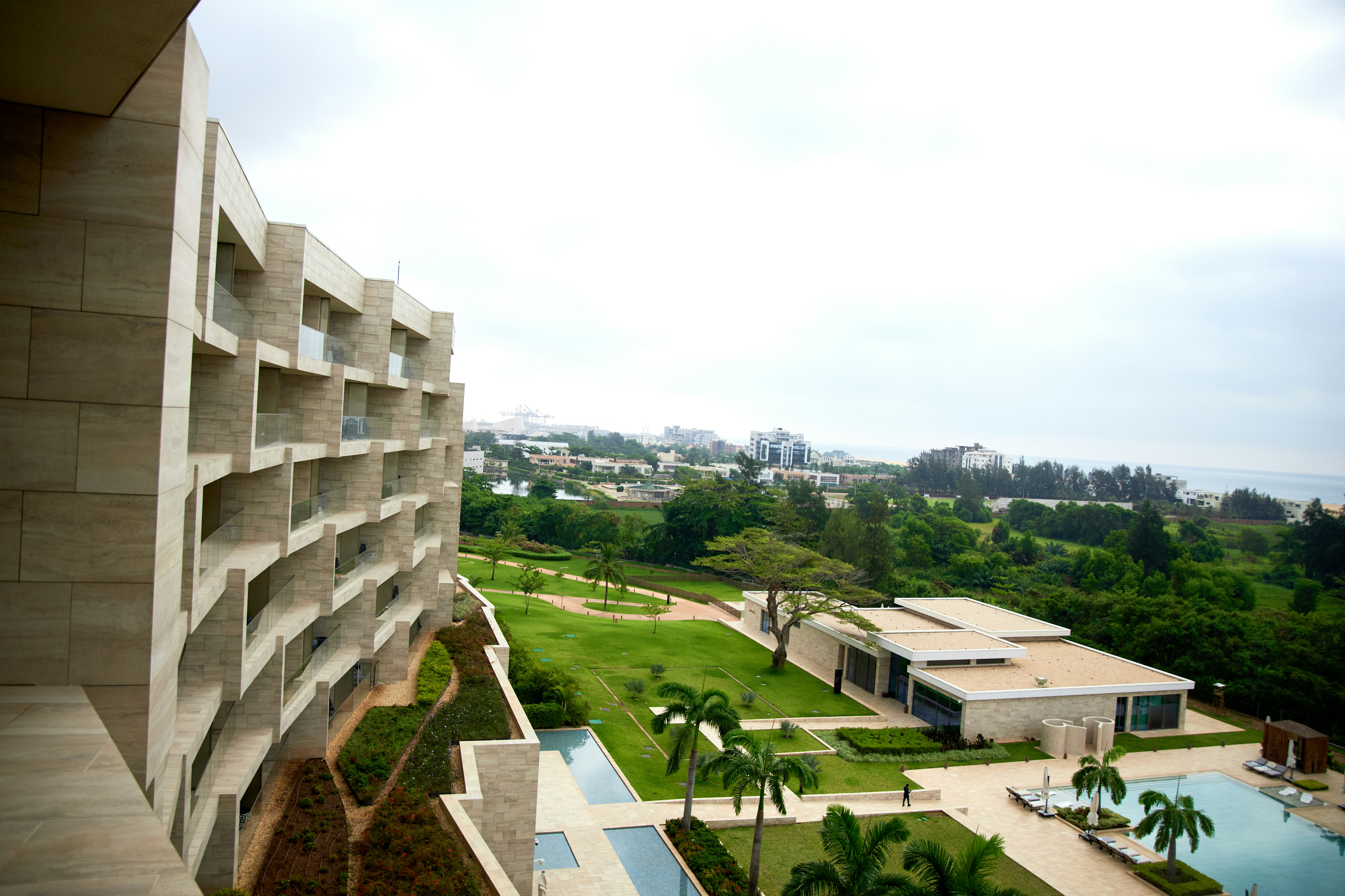 Overlooked Campus Terrace: Modern Concrete Facade Against Verdant Grounds