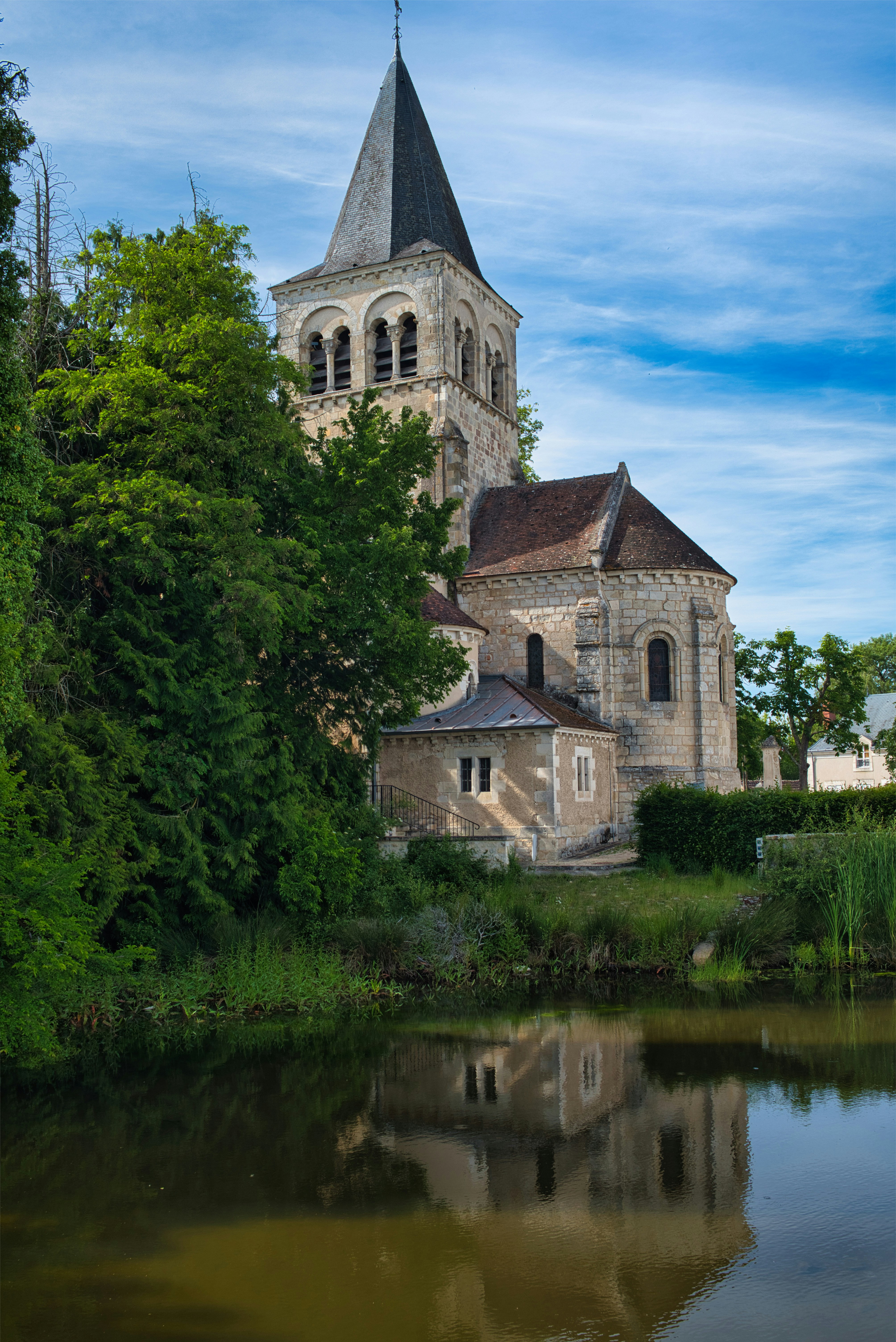 Stone Bell Tower Rising from Riverside Pasture
