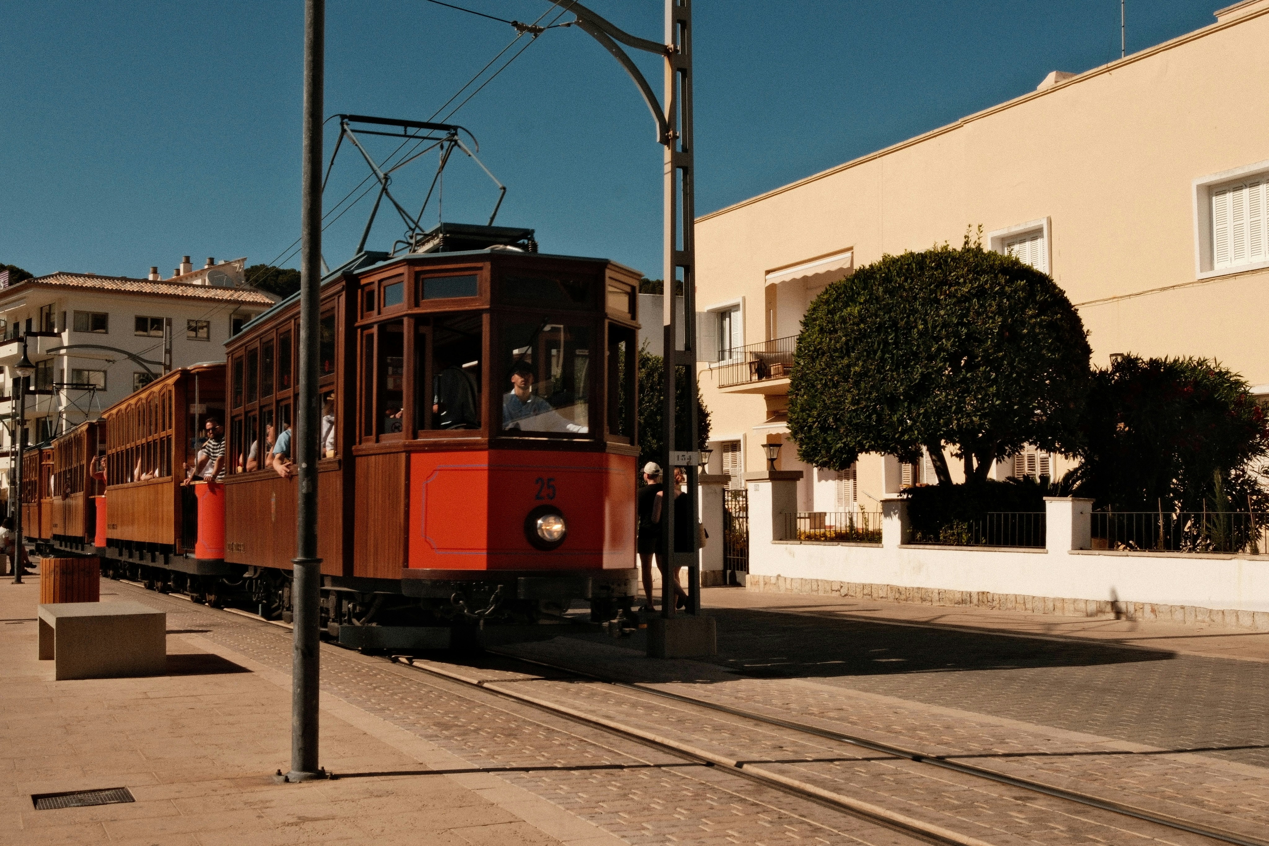 Red Tram at a Sunny Mediterranean Crossing