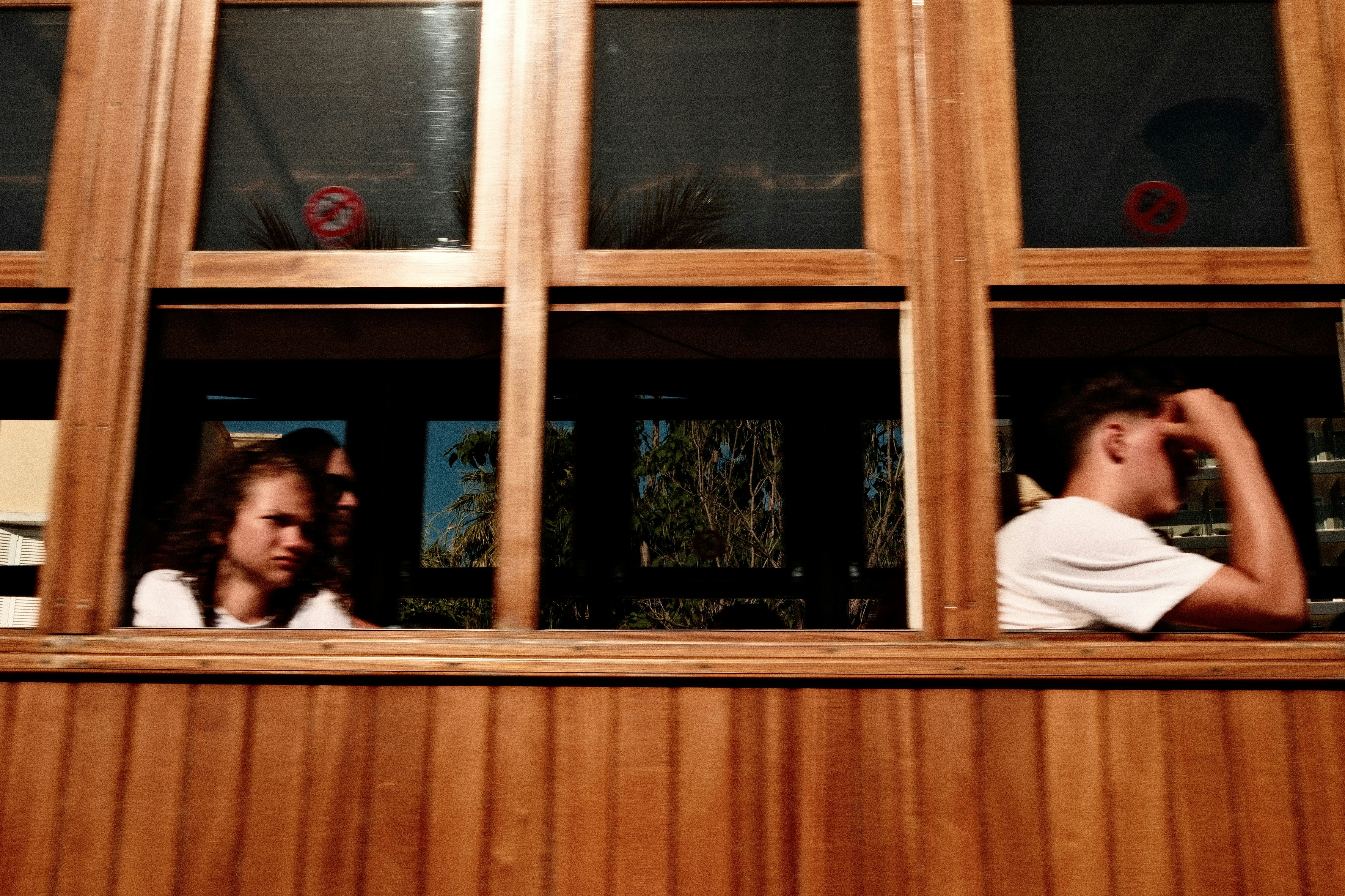 Windowed Beings: Two Subjects Paused in a Wooden Frame