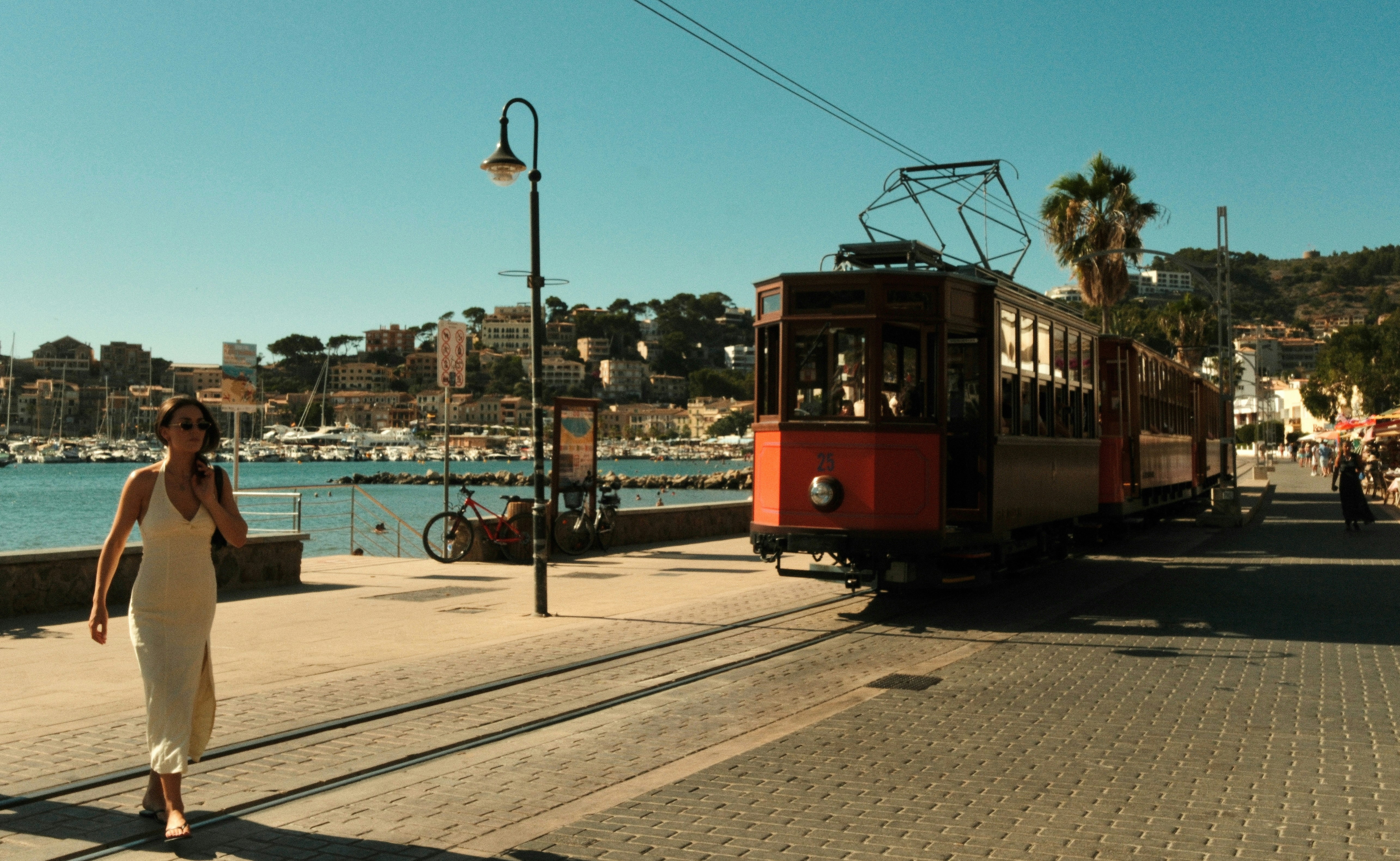 Coastal Tramline: A Sunlit Promenade with a Dapper Lady