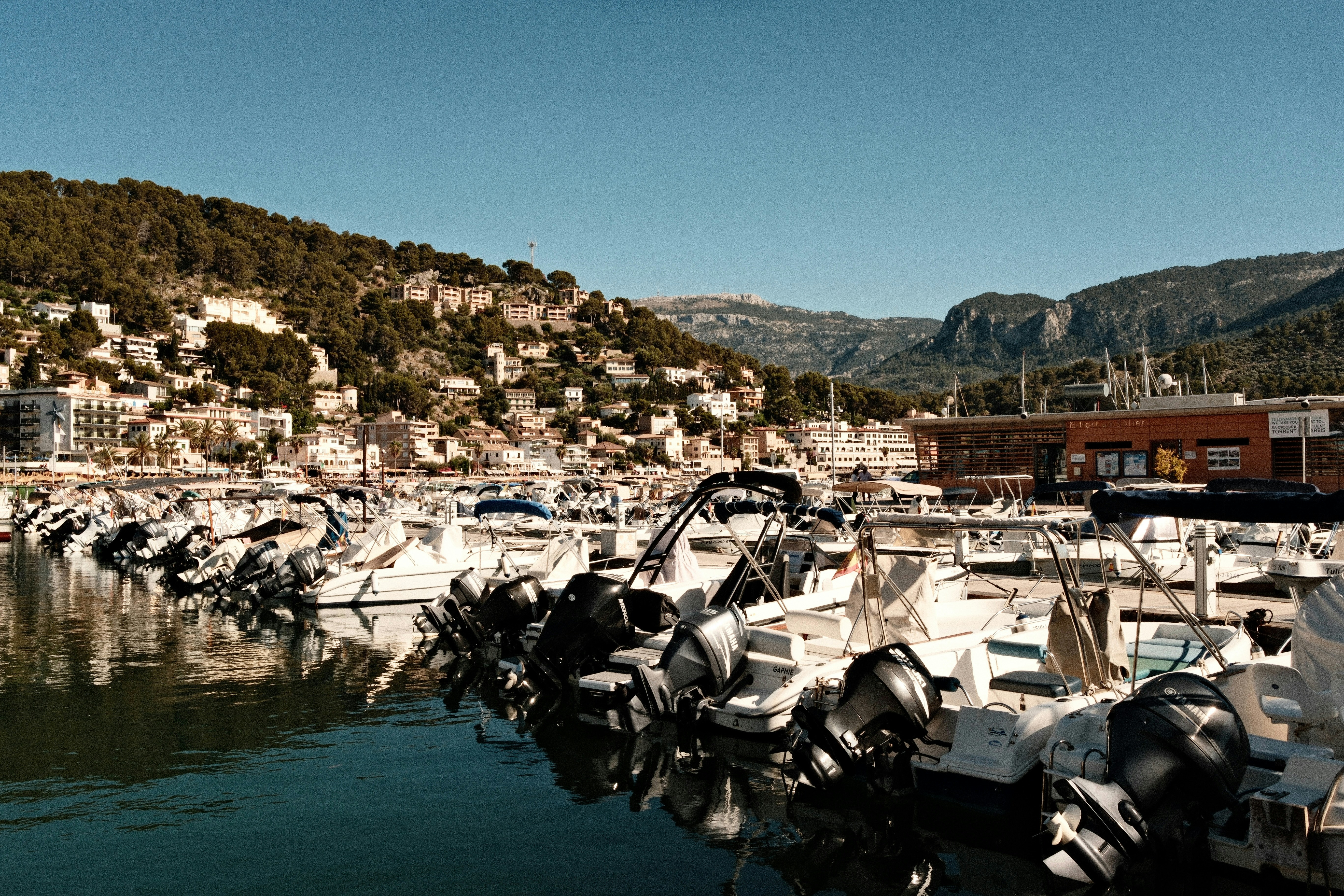 Harbor of Distant Lights: Boats Rest at Classic Moorings in a Sunny Coastal Town