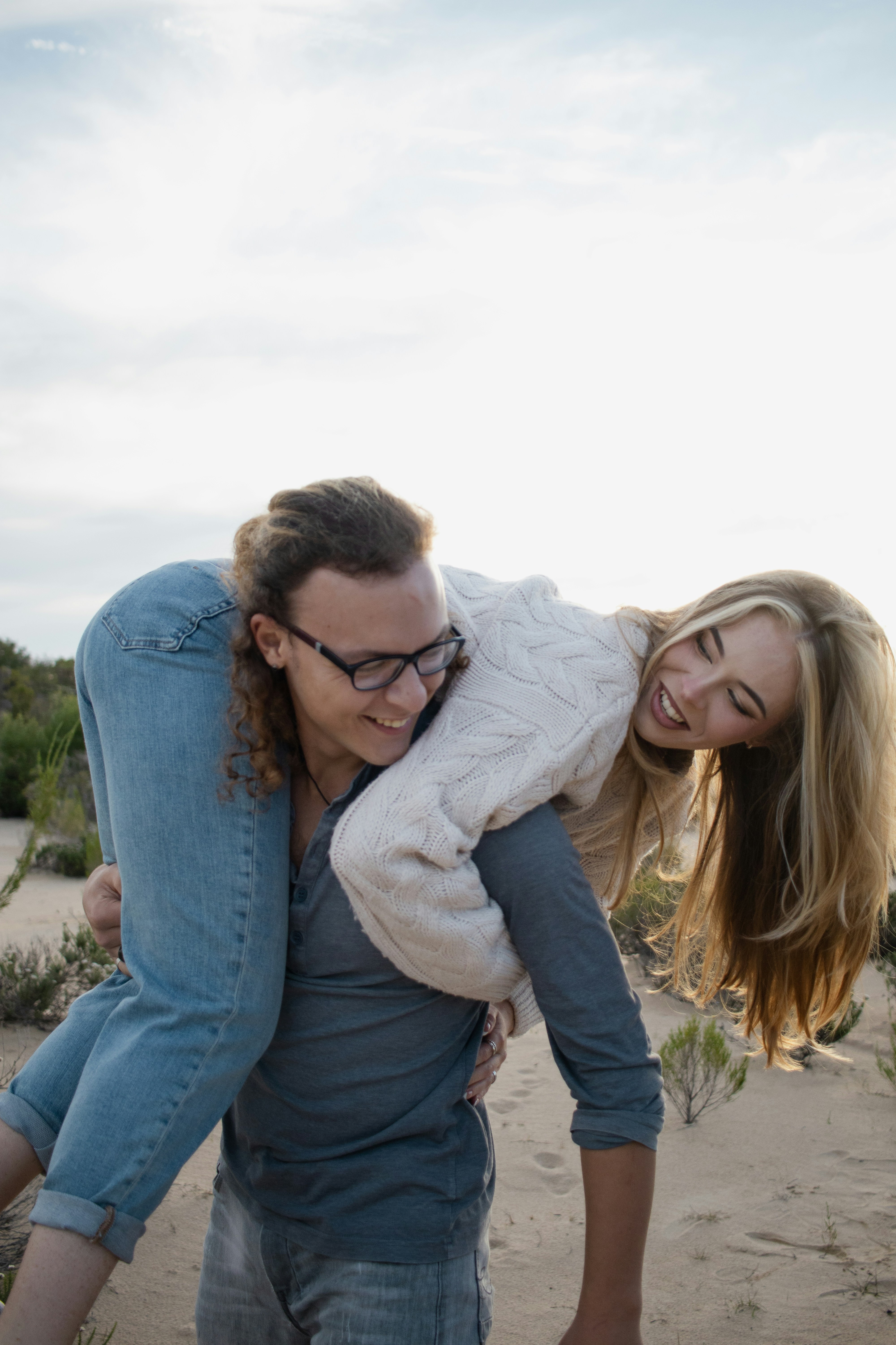 Two Friends Share a Joyful Moment: A Sand-Swept Hideaway Adventure