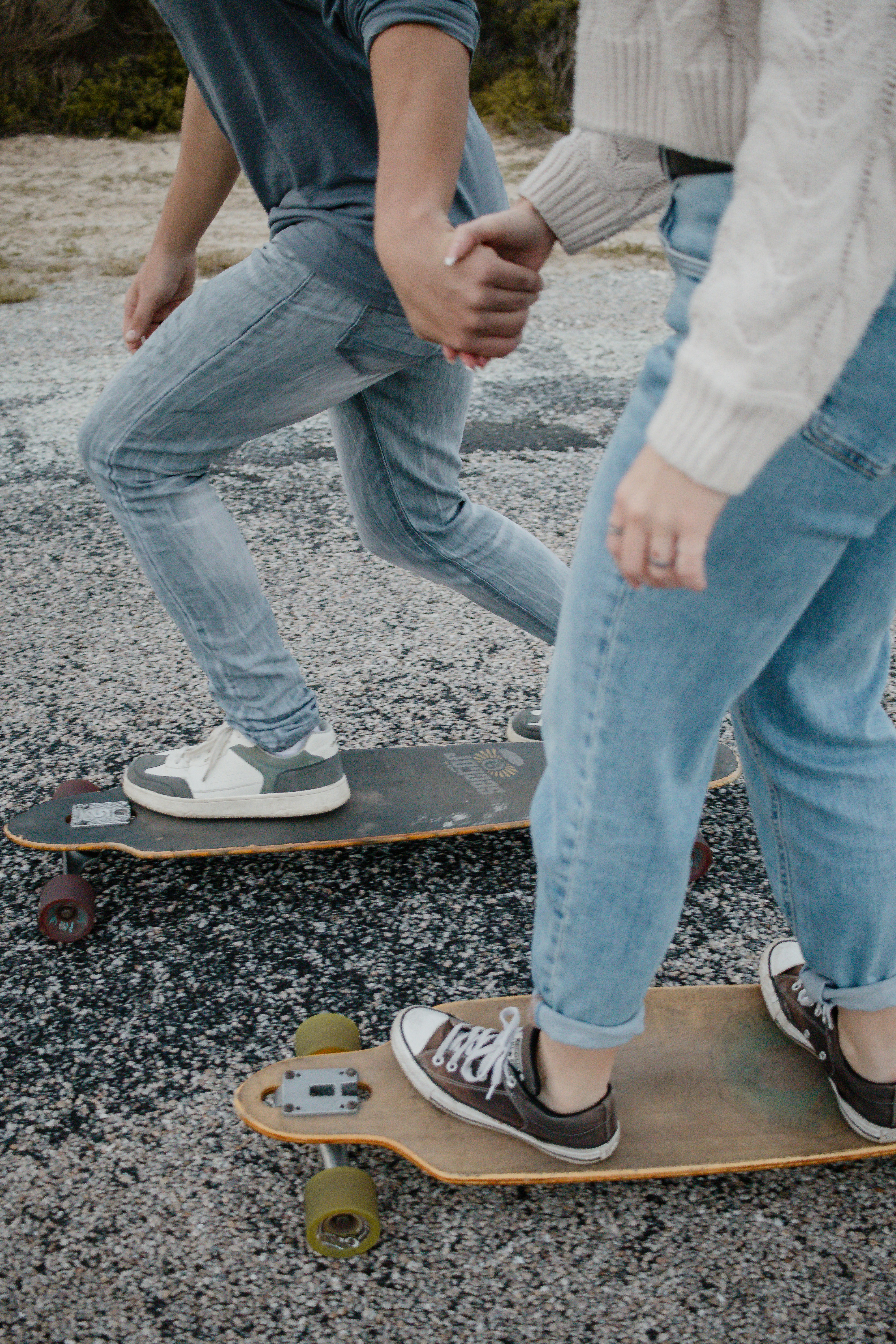 Hands in Tandem: Riders and Boarders on a Sunset-Street Stroll