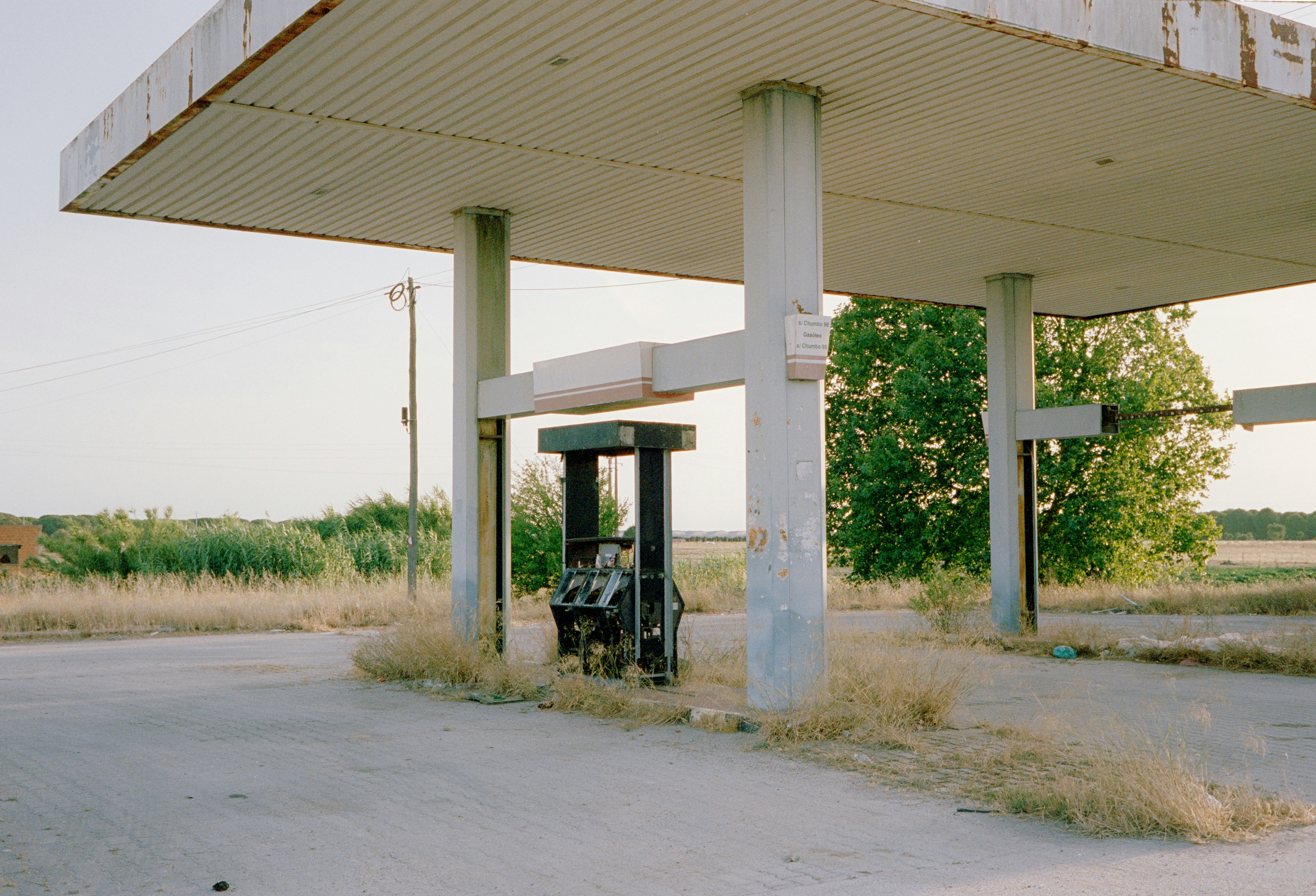 Abandoned Gas Station Canopy Over Dry Field