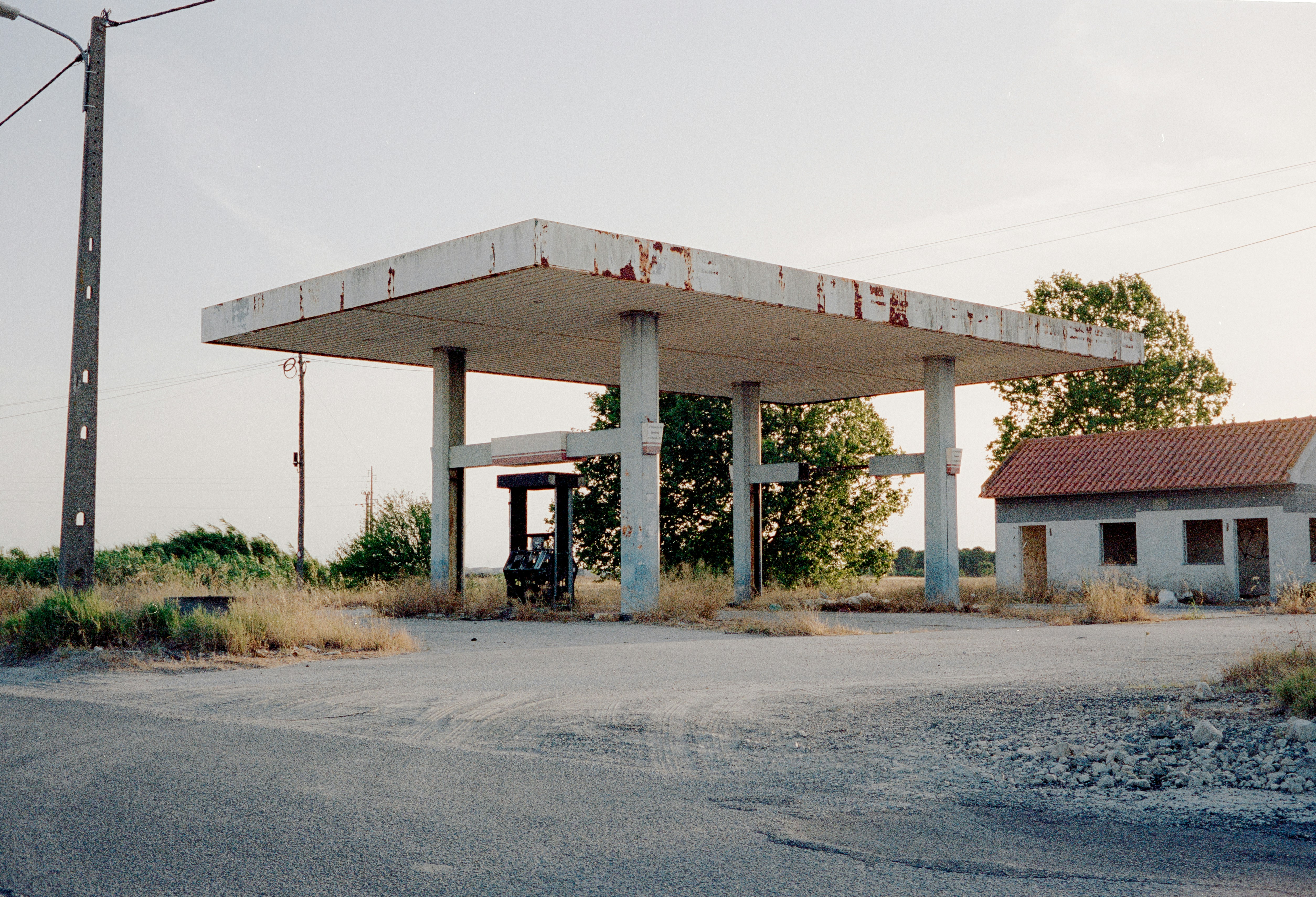 Abandoned Service Station Amid Sparse Terrain