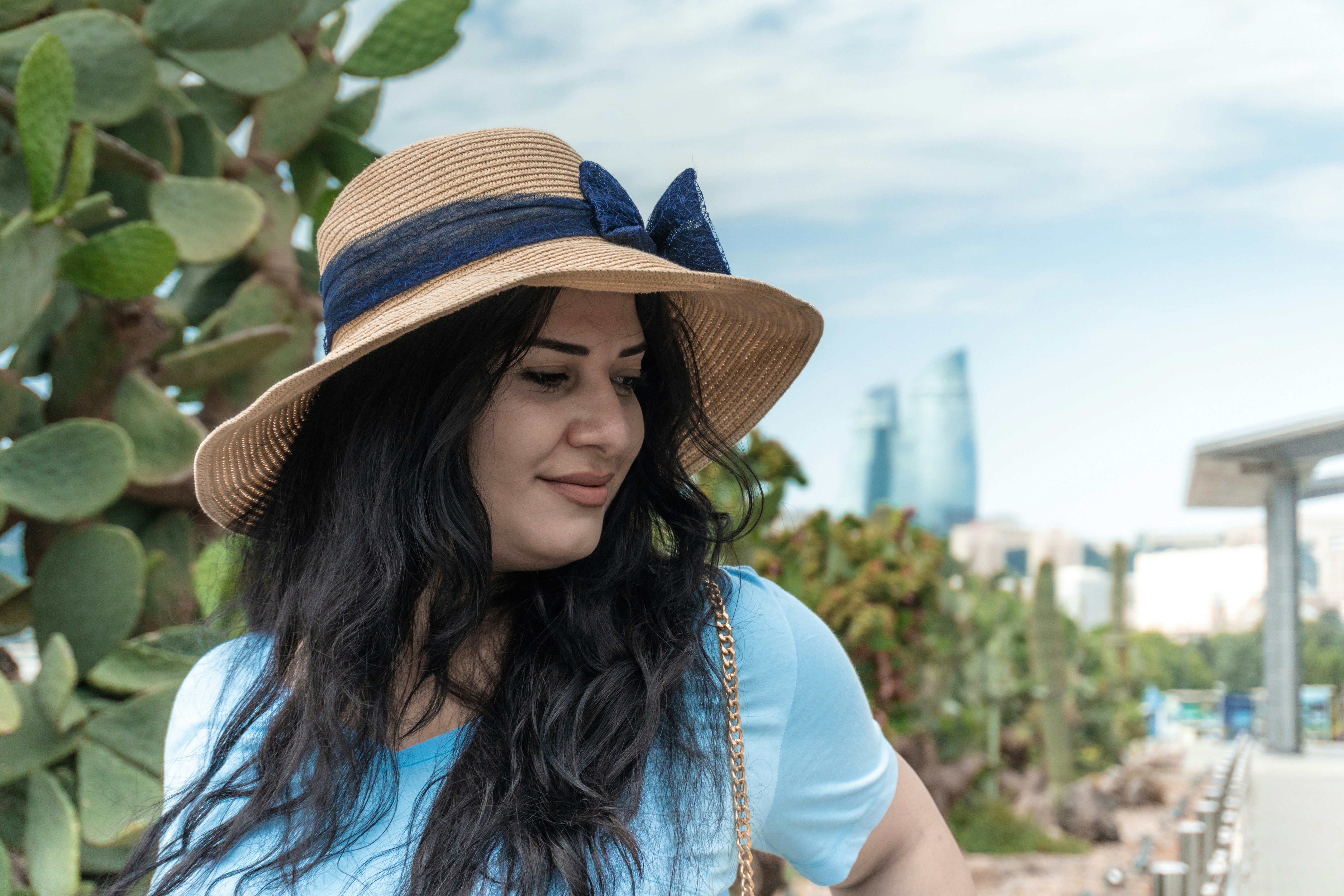 Sunlit Confidence: A Portrait in a Straw Hat by the Coastal Path