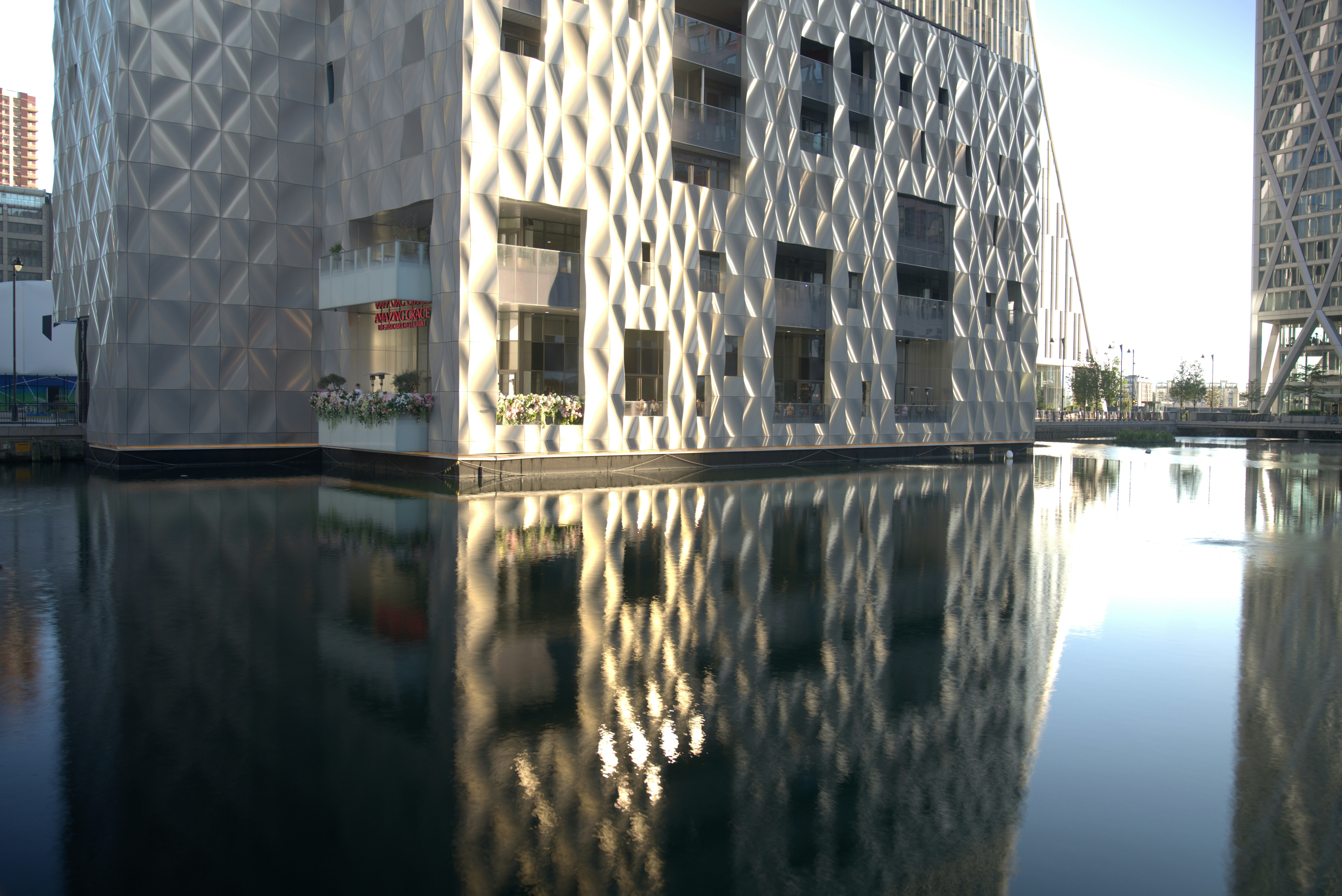 Reflected Facades: A Pair of Diamond-Textured Buildings Rising from Quiet Water